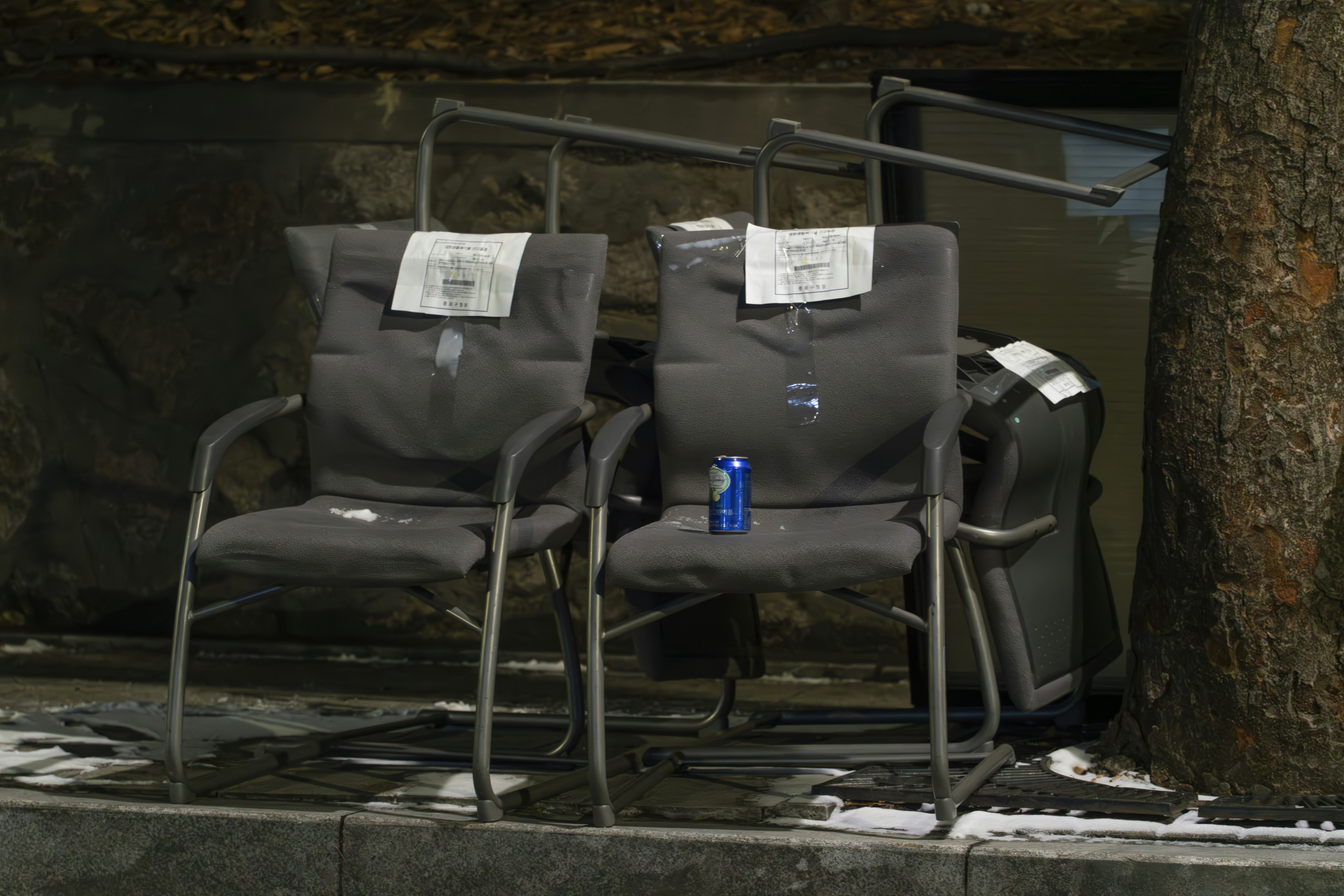 Frosted Terrace Chairs with Taped Notes and a Lone Can