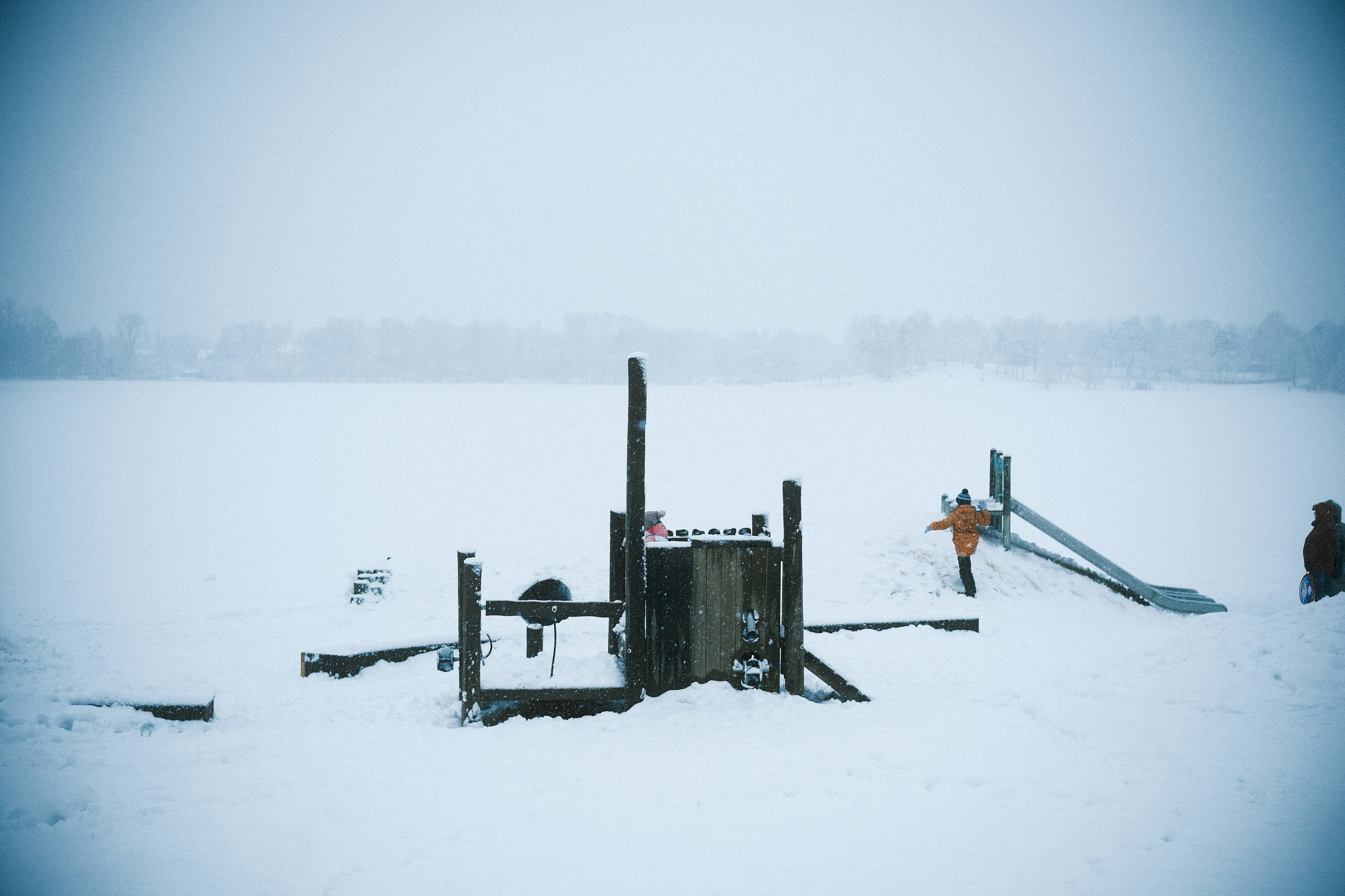 Snowbound Playground by the Frozen Lake: A Quiet Blue Winter Scene