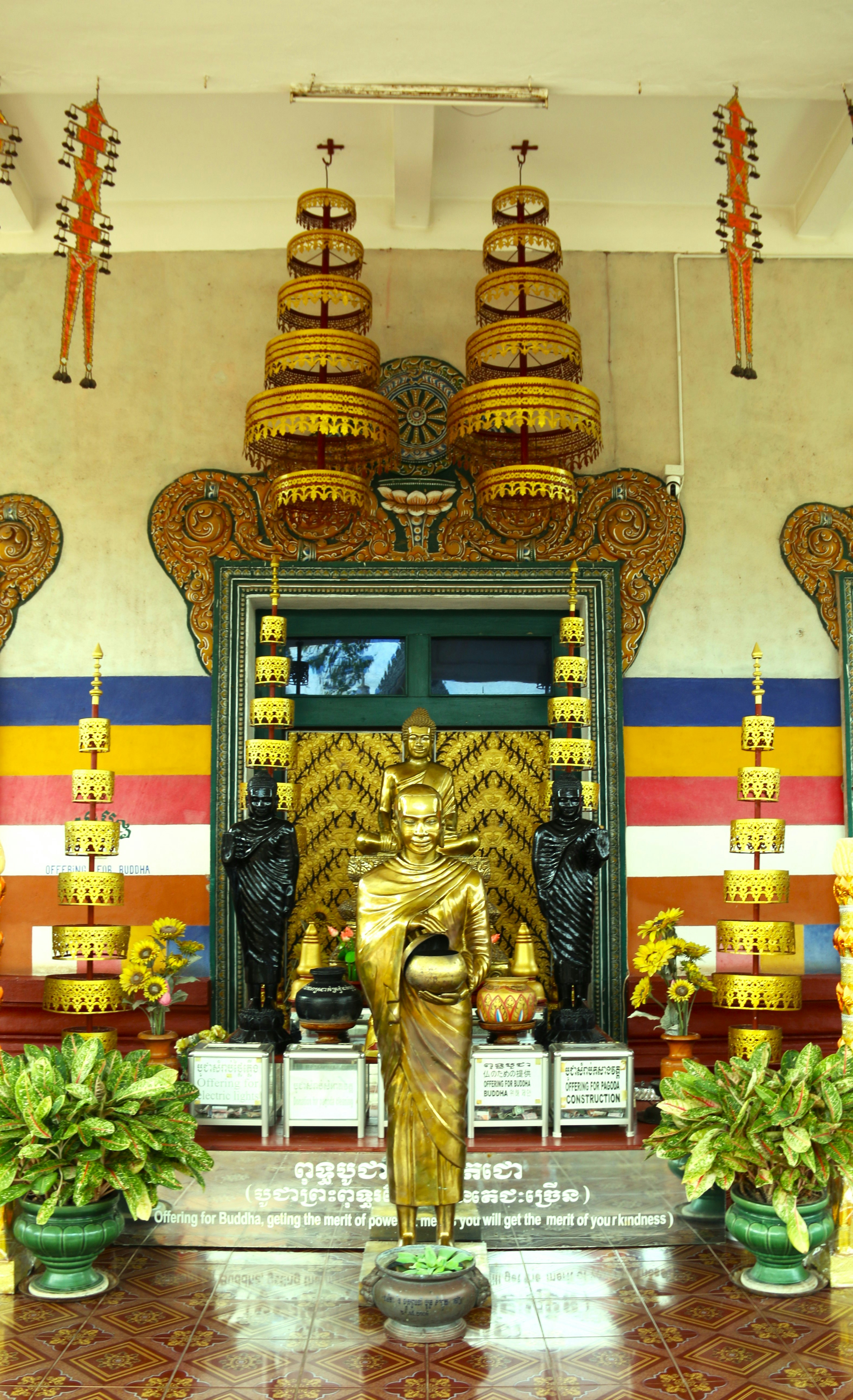 Gilded Monk at a Multicolored Buddhist Shrine, Framed by Tiered Lanterns