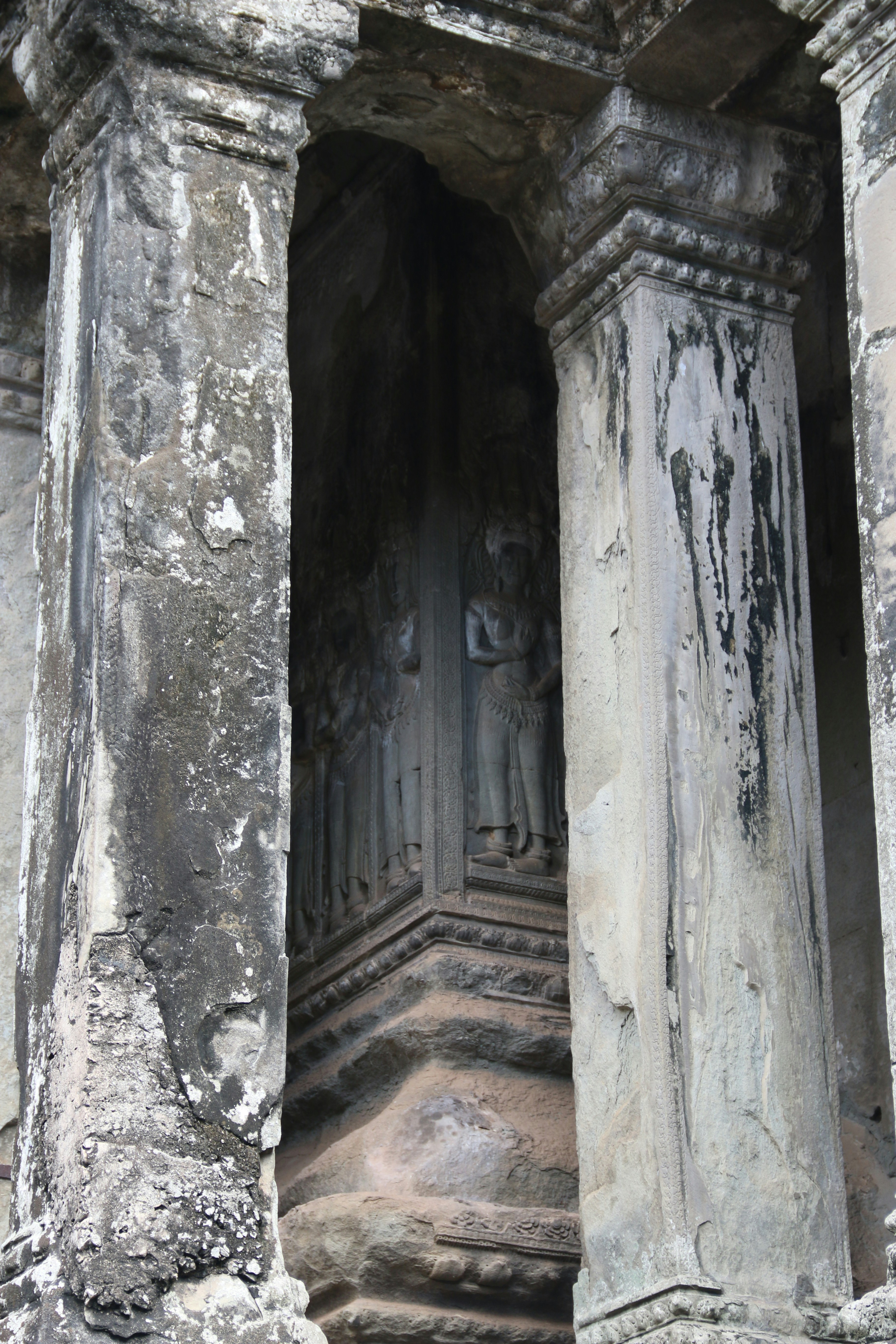 Stone Curtain: A Hidden Shrine Framed by Weathered Columns