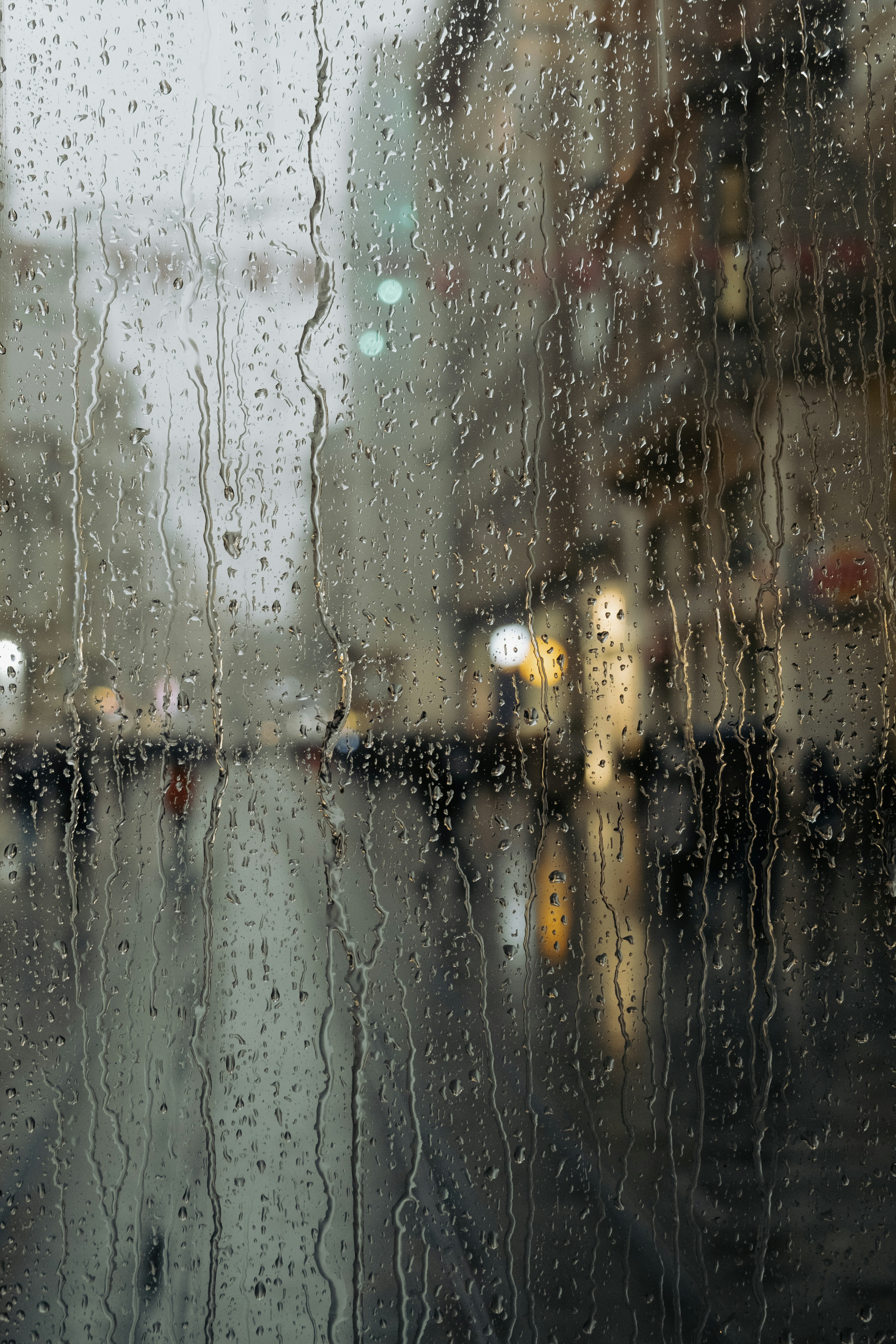 A view of a city street through a rain covered window photo – Free ...
