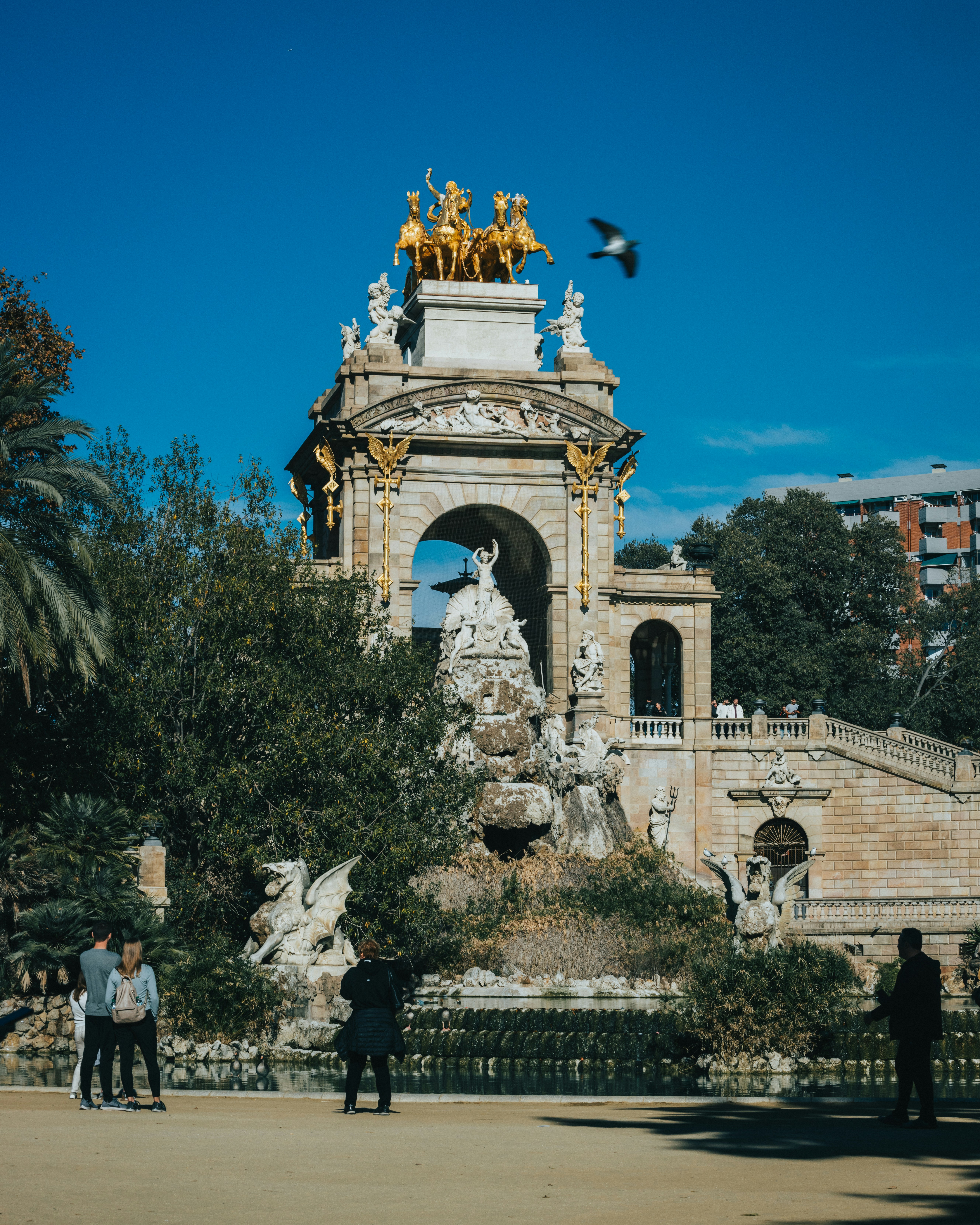 Golden Quadriga atop a Marble Arch: Sunlit Park Fountain