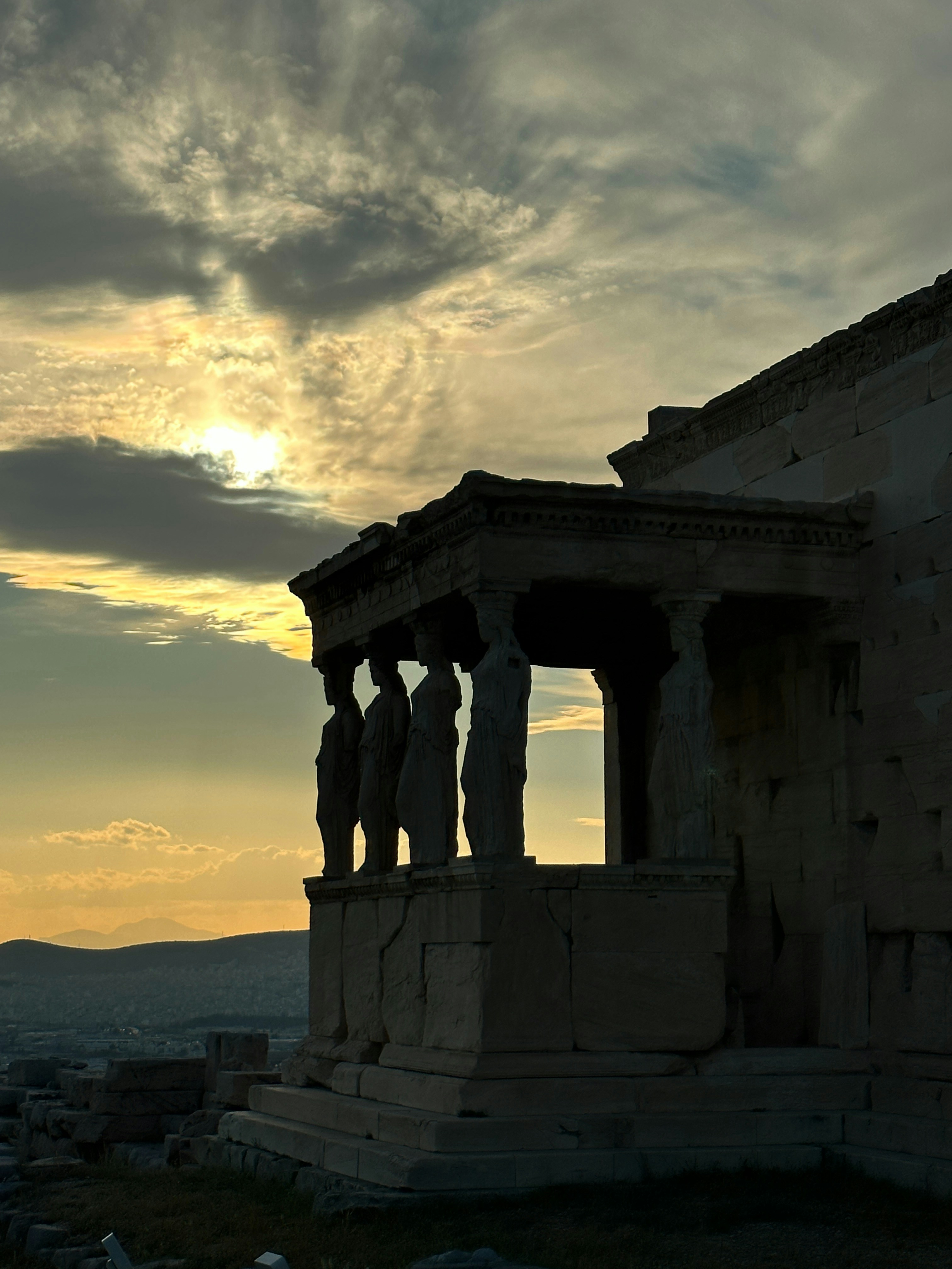 Caryatid Silhouettes at Golden Hour: Dusk Over an Ancient Temple