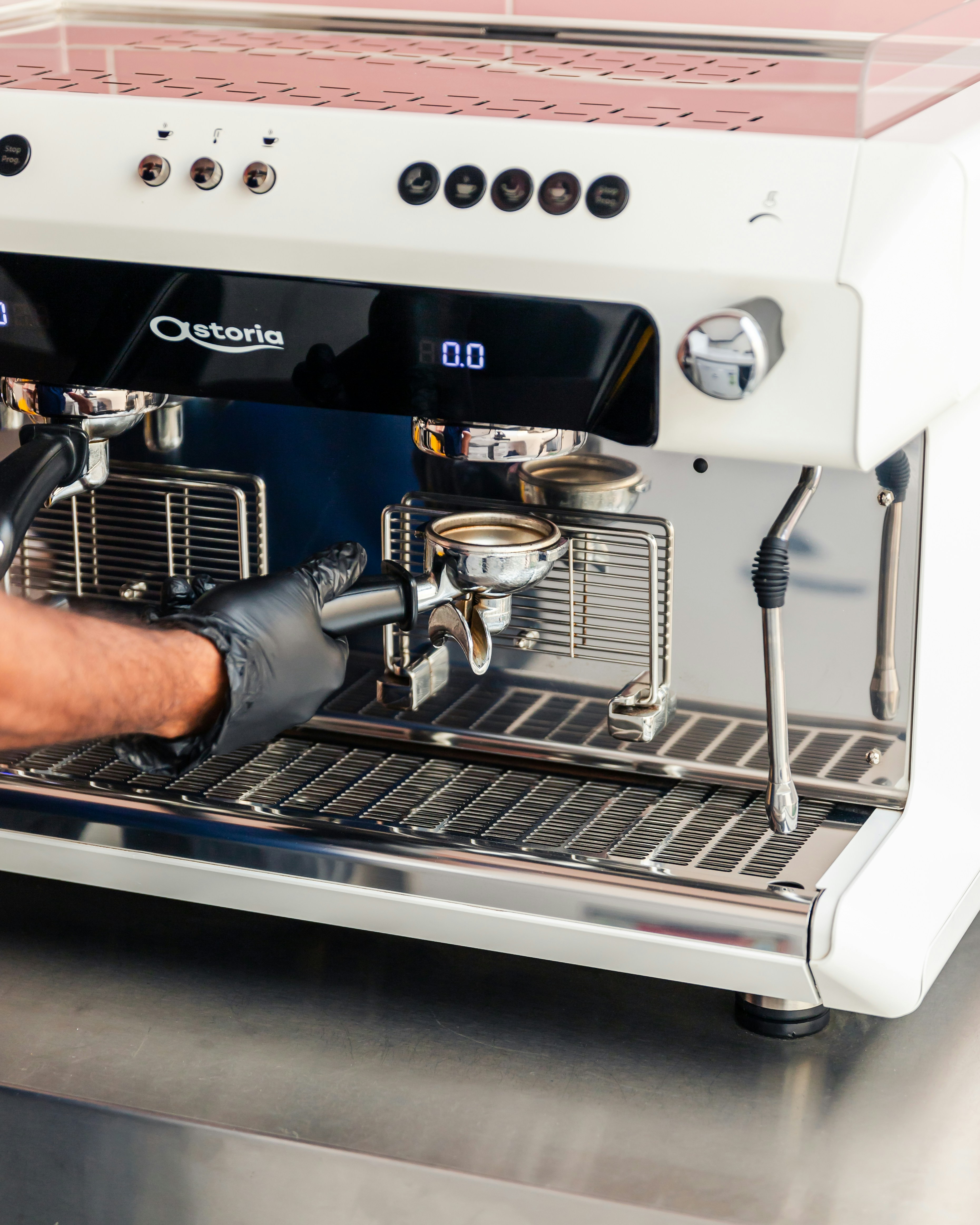 A person is using a coffee machine to make a cup of coffee photo – Free ...