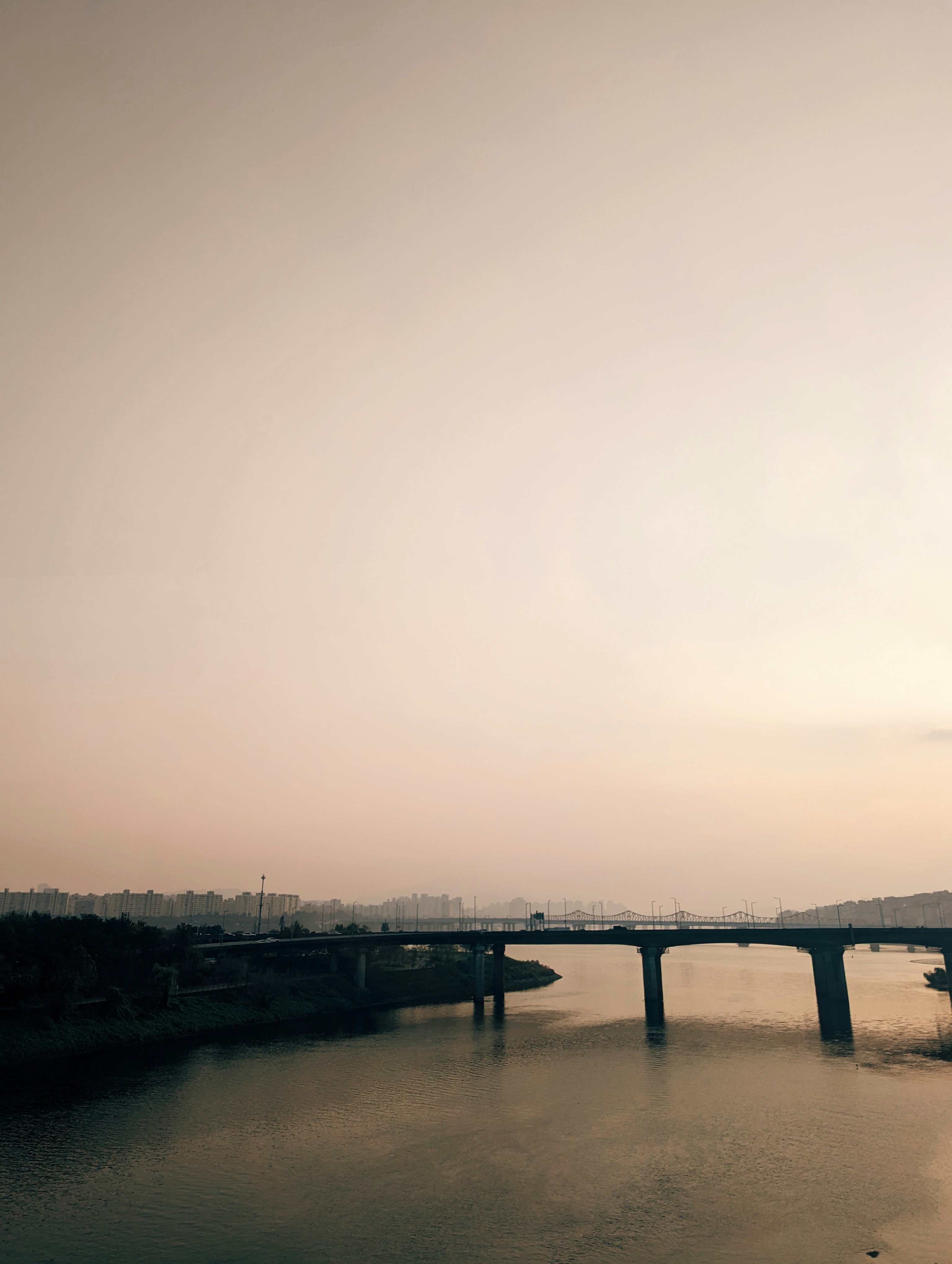 Ember-glow Bridgescape: A Riverside Crossing at Dusk