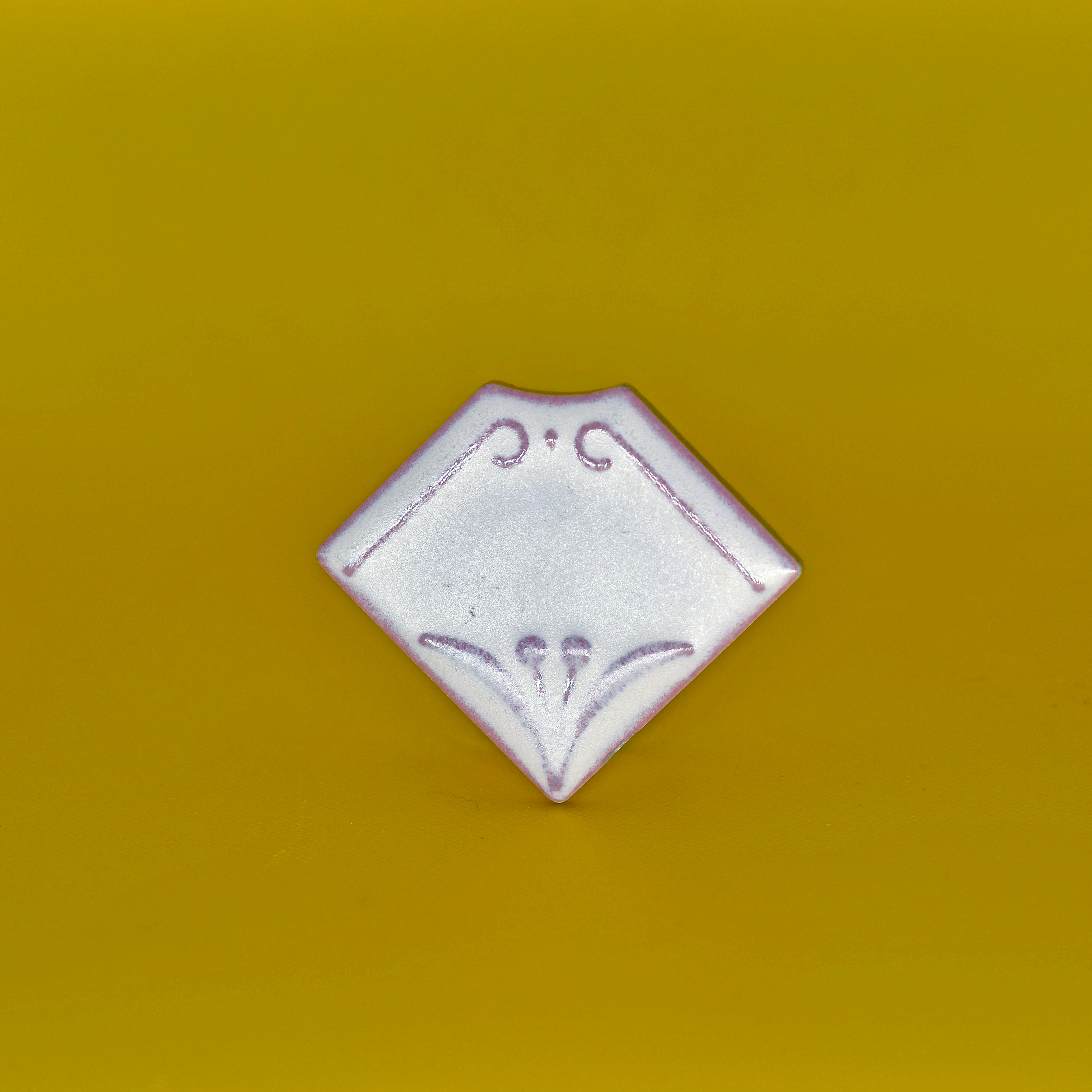 A white diamond shaped object on a yellow background photo – Free Tile ...