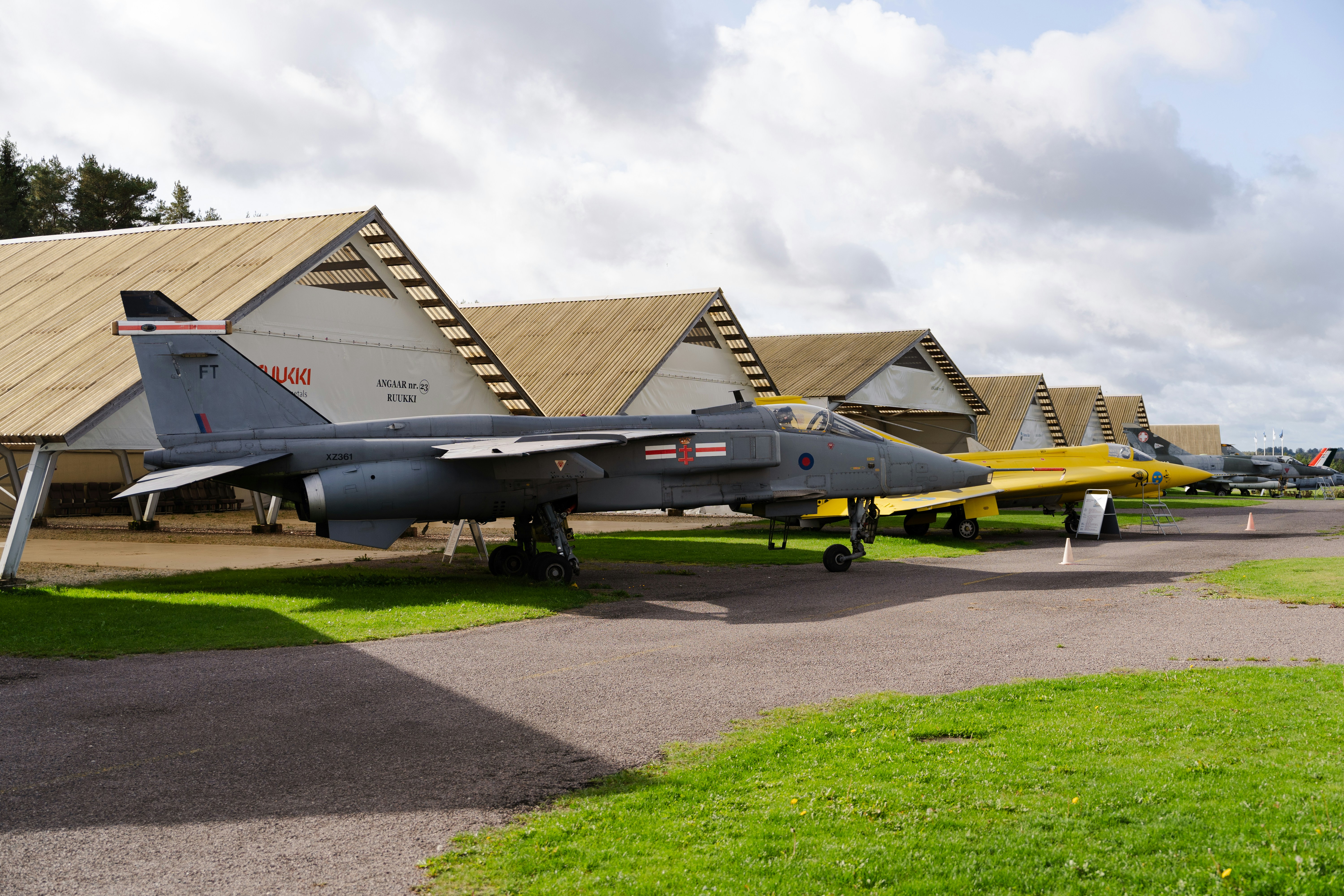 A row of fighter jets parked next to each other photo – Free Museum ...
