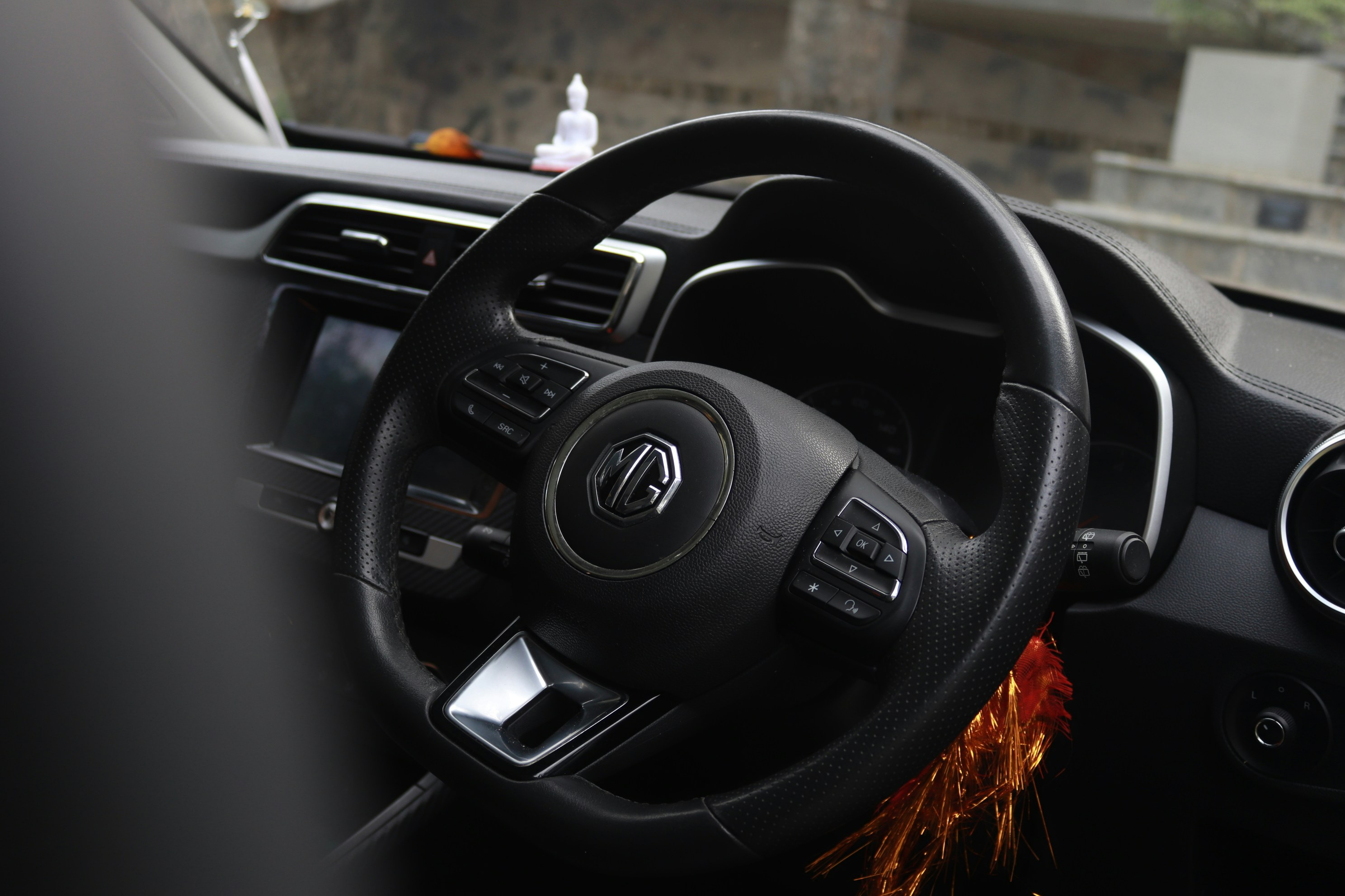 the interior of a car with a steering wheel and dashboard