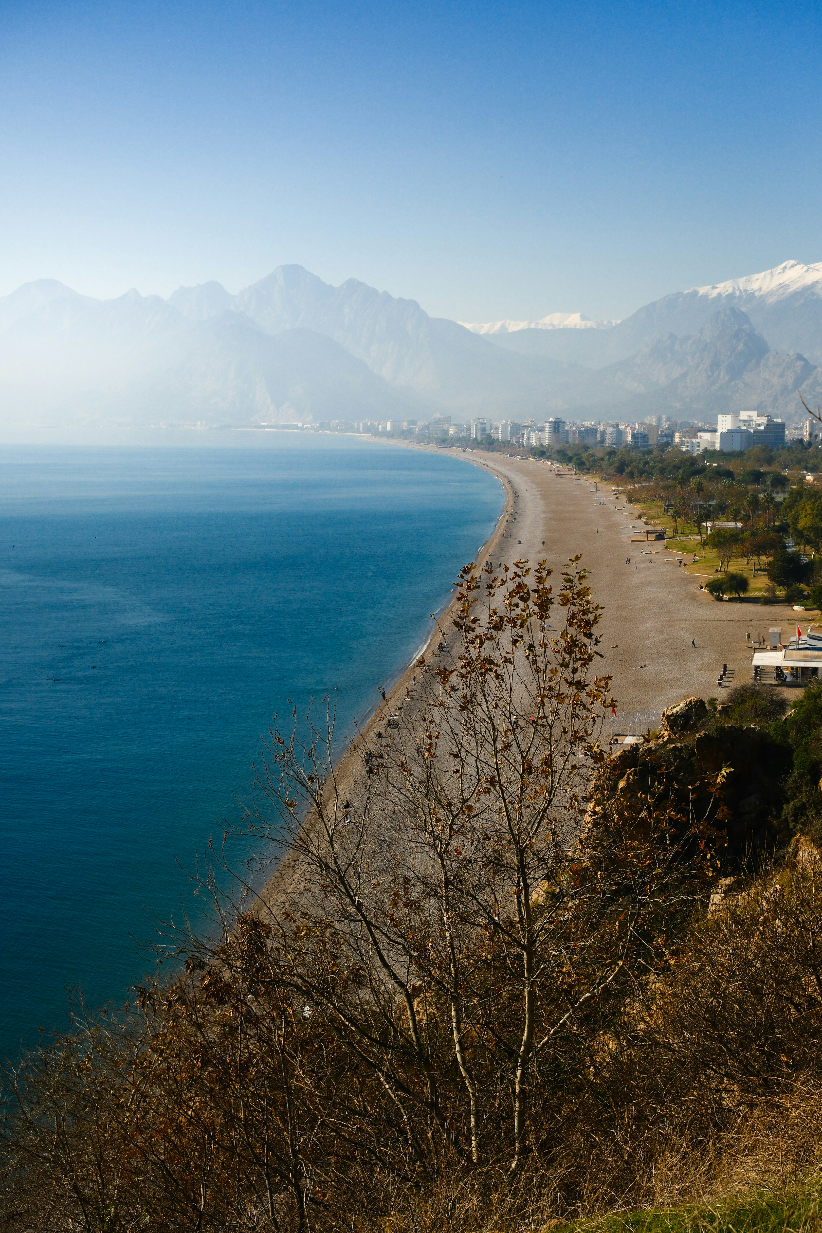 Coastal Promenade in the Shadow of Snow-Capped Peaks