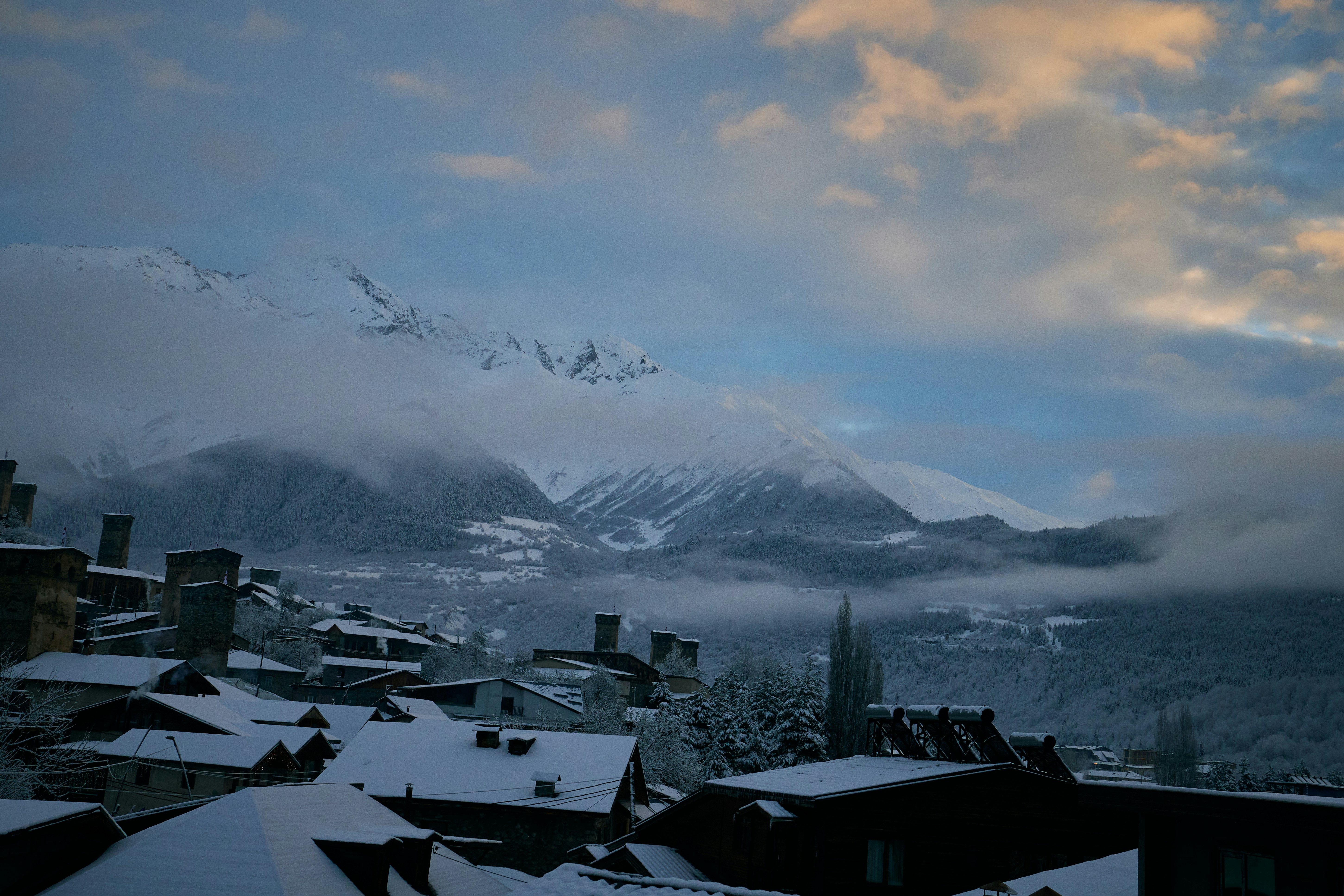 Mist-Softened Peaks Over a Snow-Capped Alpine Village
