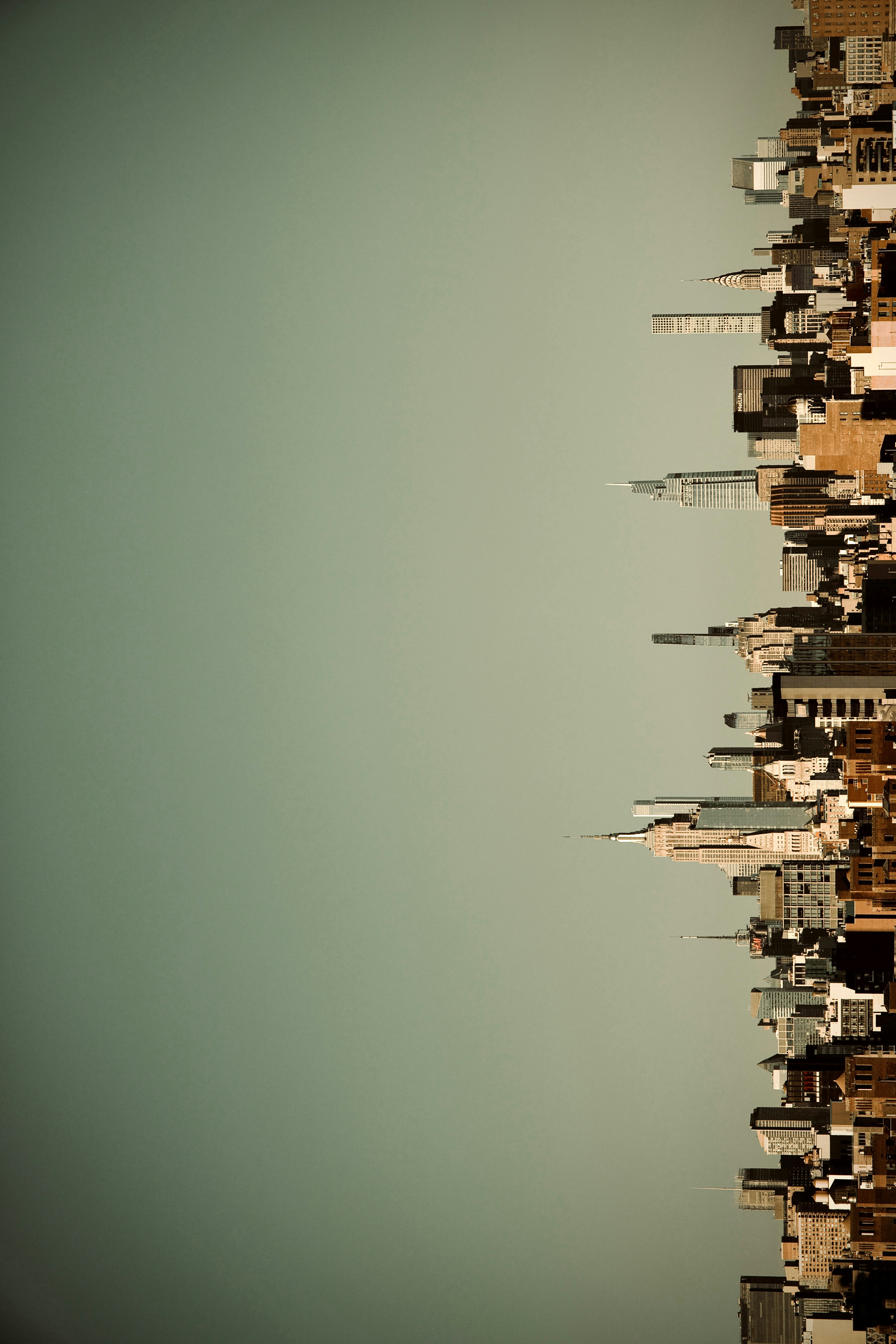 Vertical Cityscape: A Golden-Toned Skyline Against a Gentle Horizon