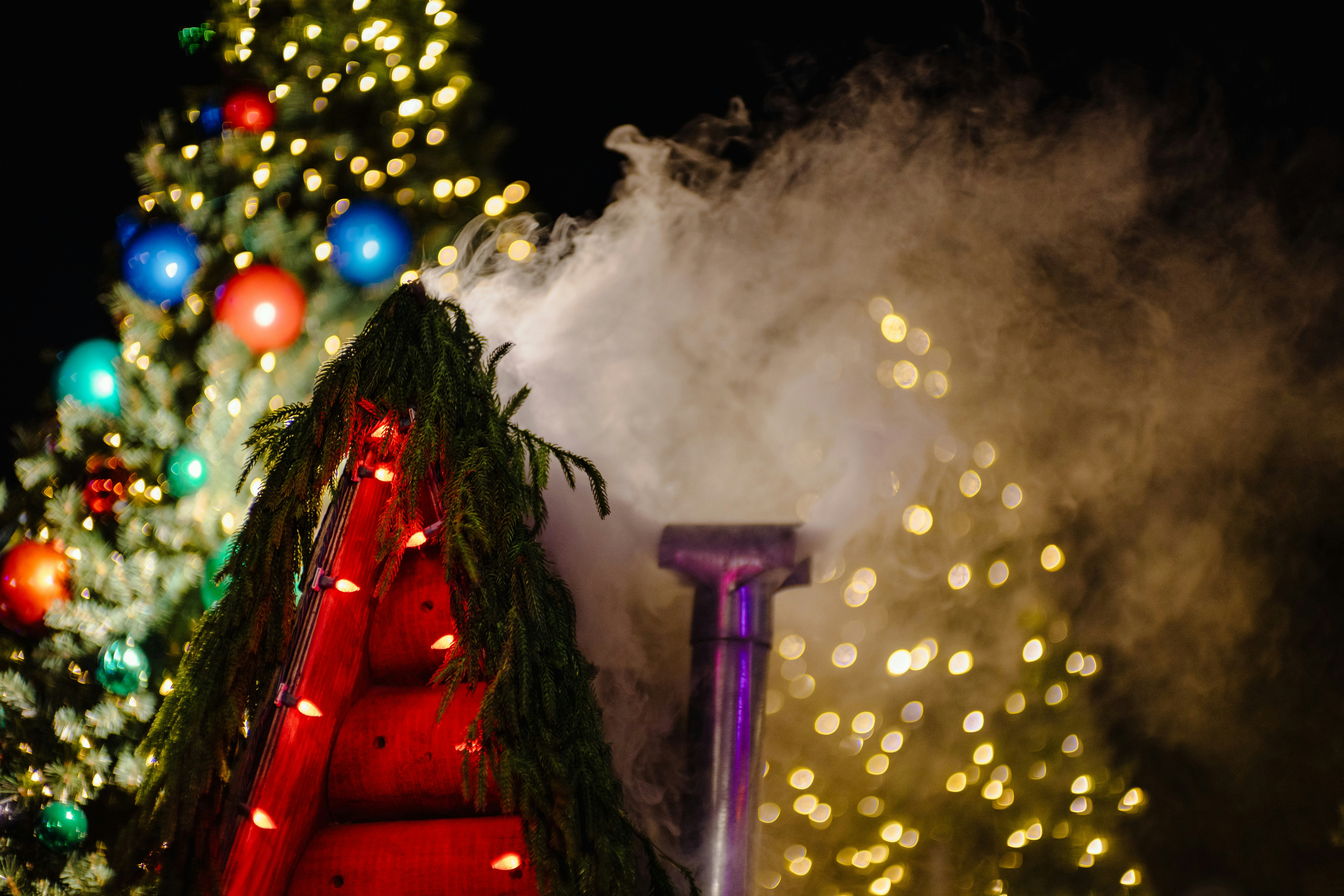 Festive Glow: A Christmas Tree and Smoke Ignite the Night