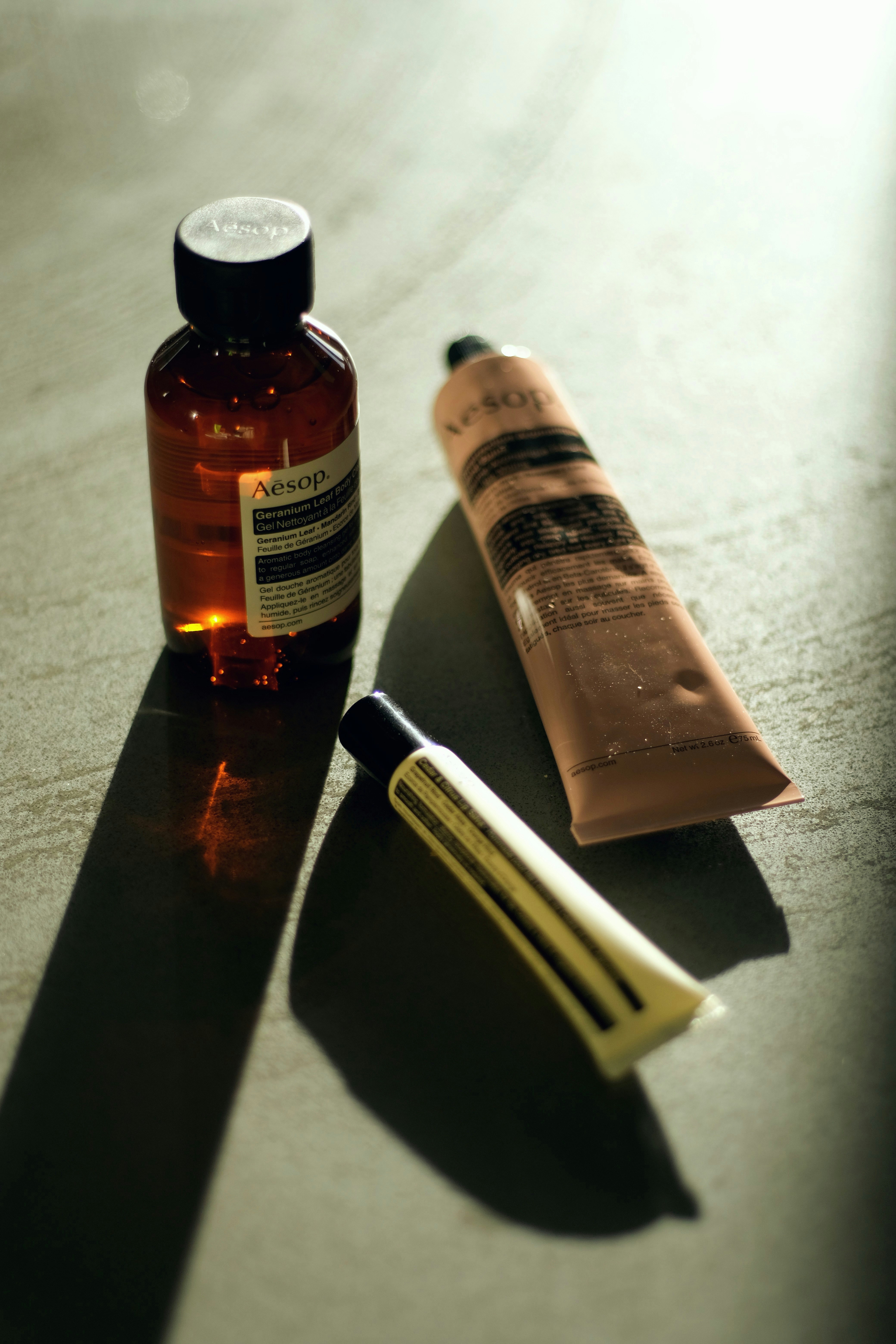 A tube of toothpaste next to a bottle of toothpaste photo – Free Dark ...