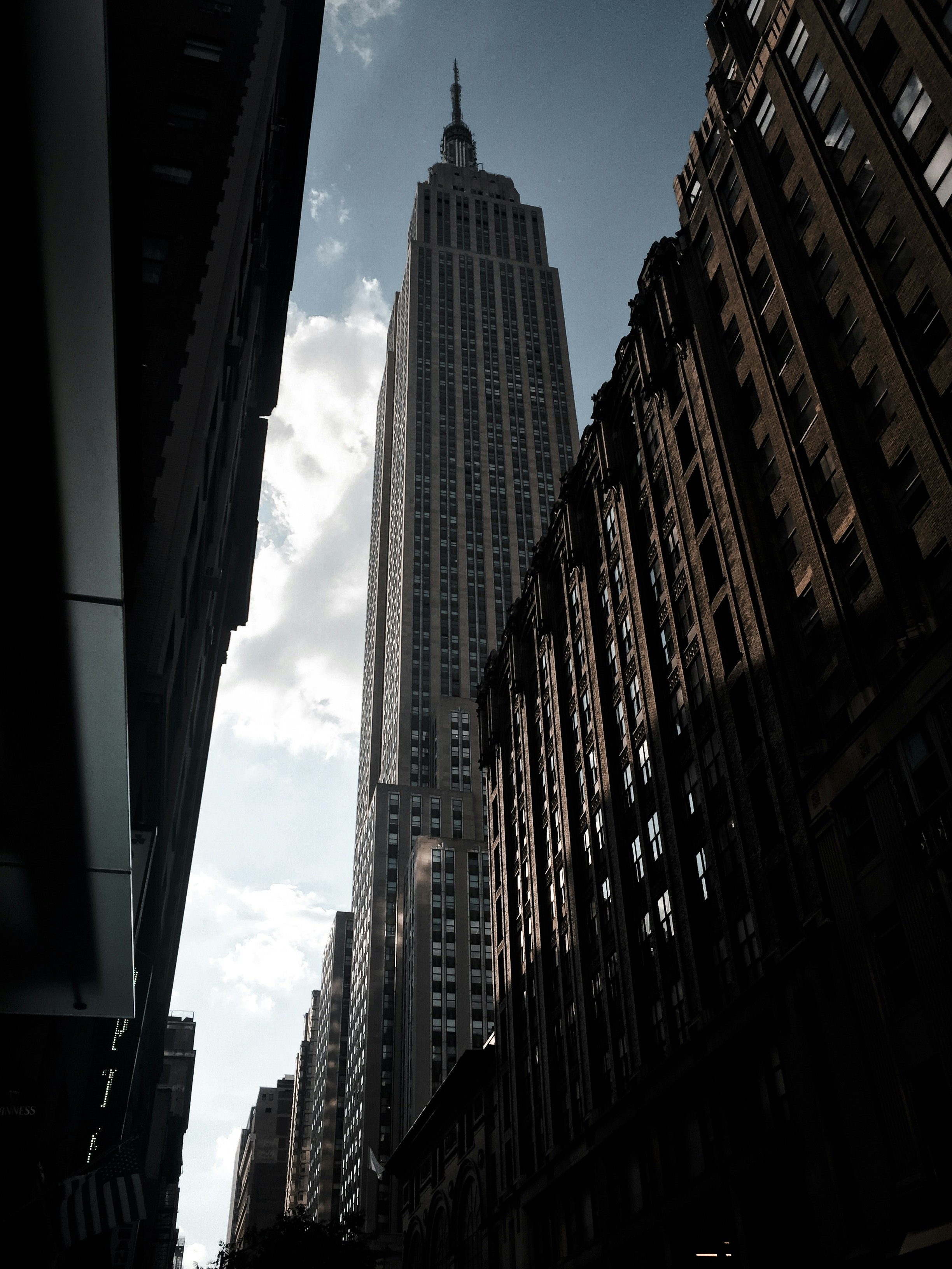 A tall building towering over a city filled with tall buildings photo ...