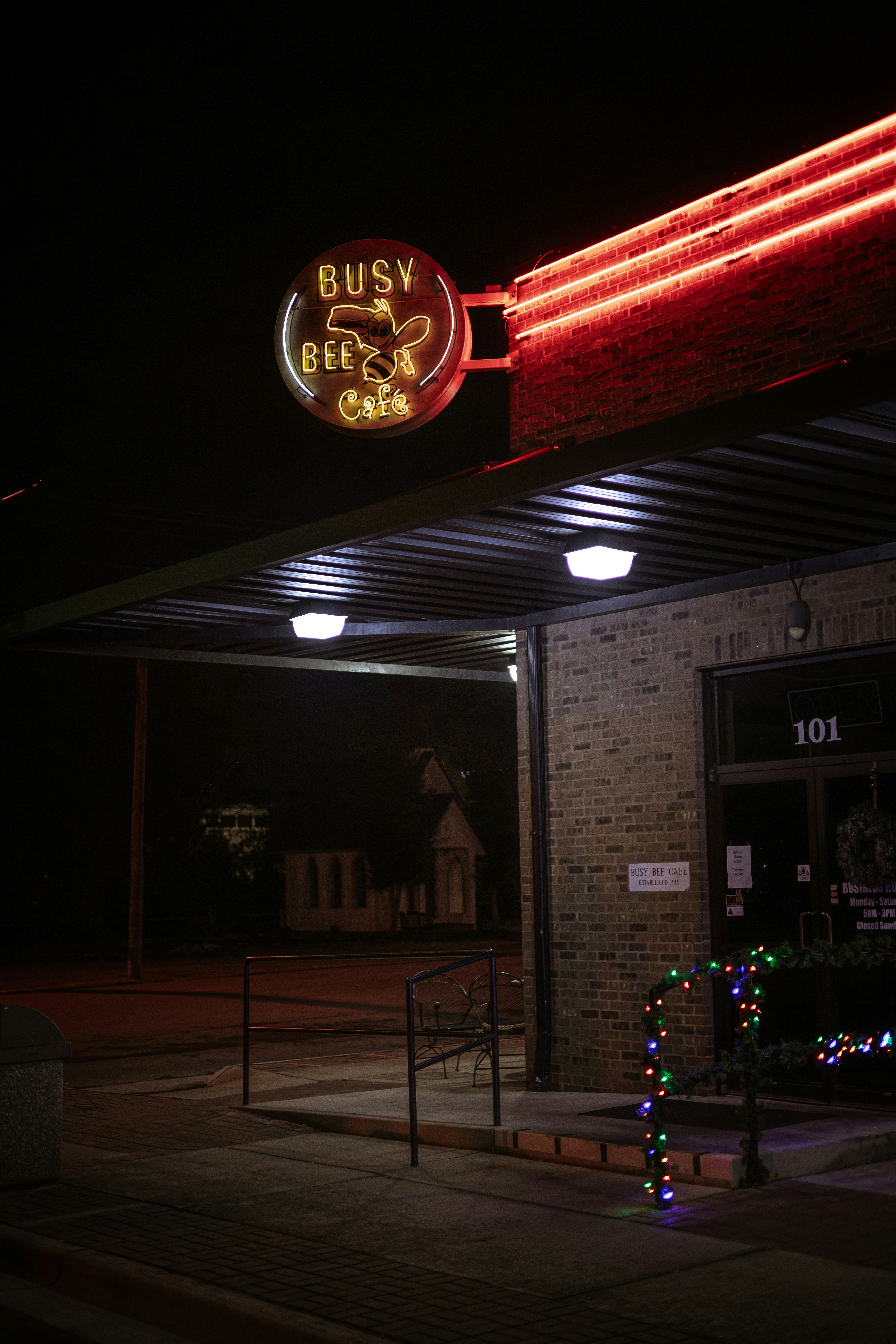 Neon Halo Above the Quiet Street: Busy Bee Cafe at Night