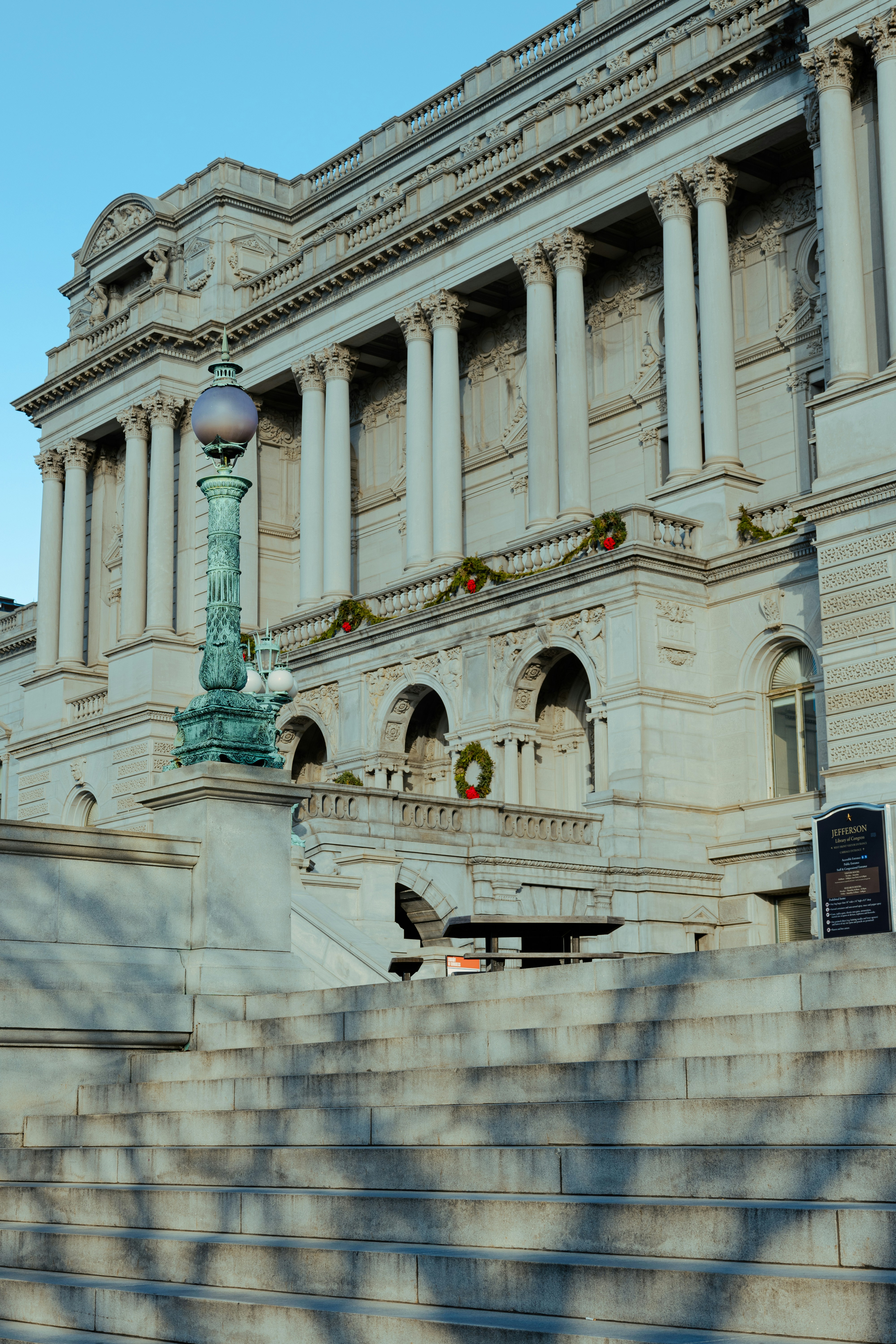 Blue Sky over Marble: Lantern, Stairs, and Arched Facade