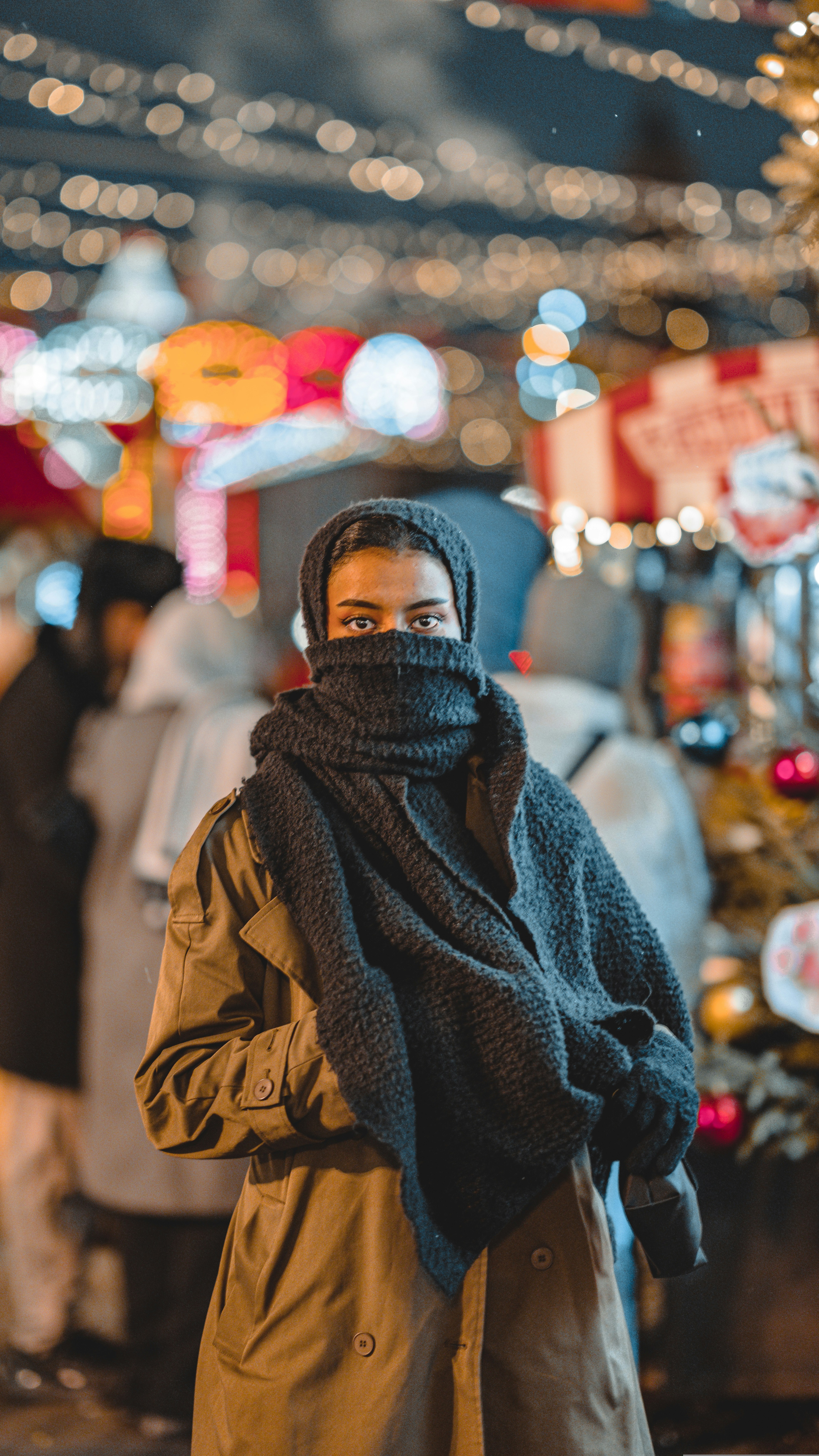 Midnight Market Gaze: A Cloaked Portrait Among Neon Bokeh