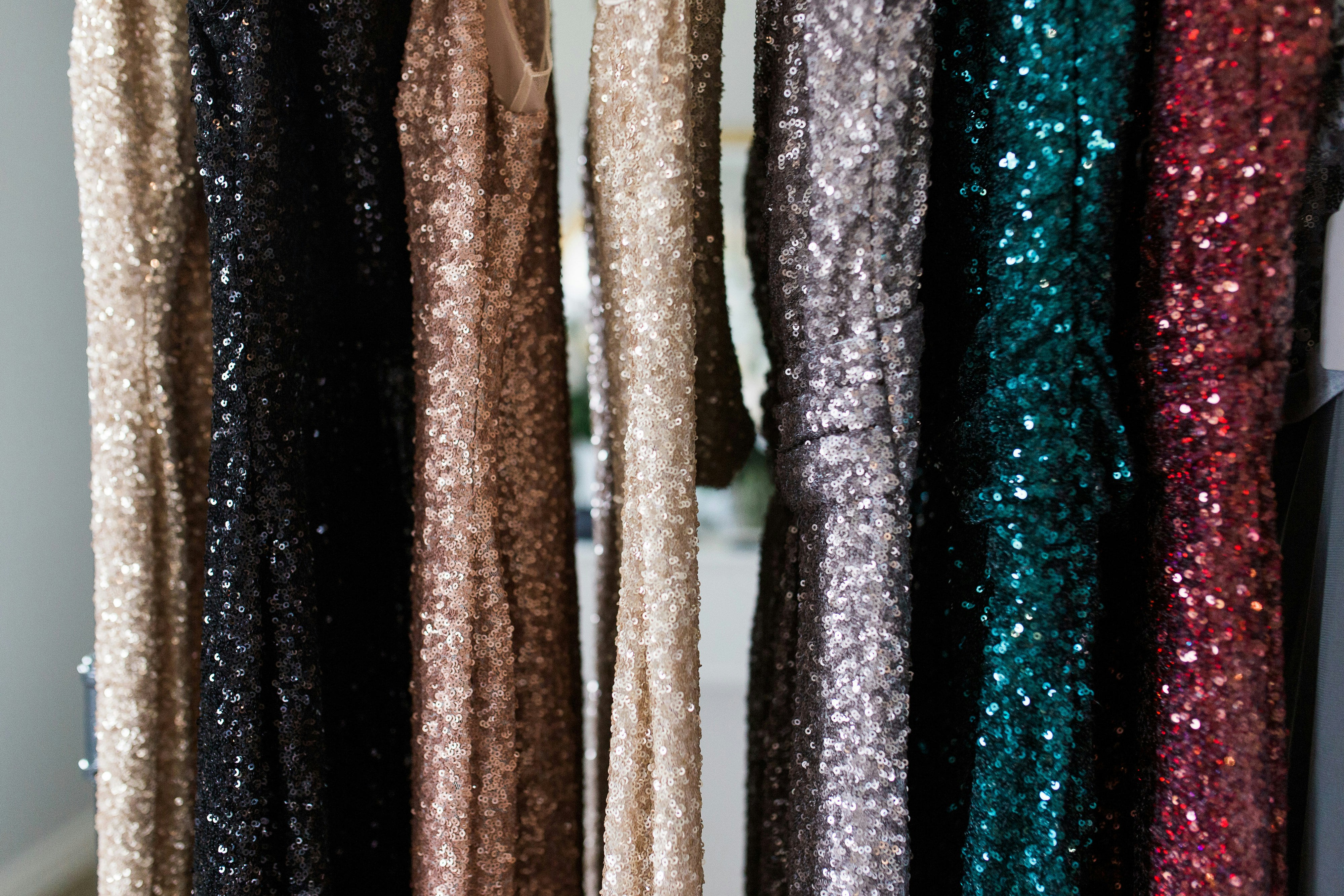 A bunch of different colored sequins hanging on a wall photo – Free ...