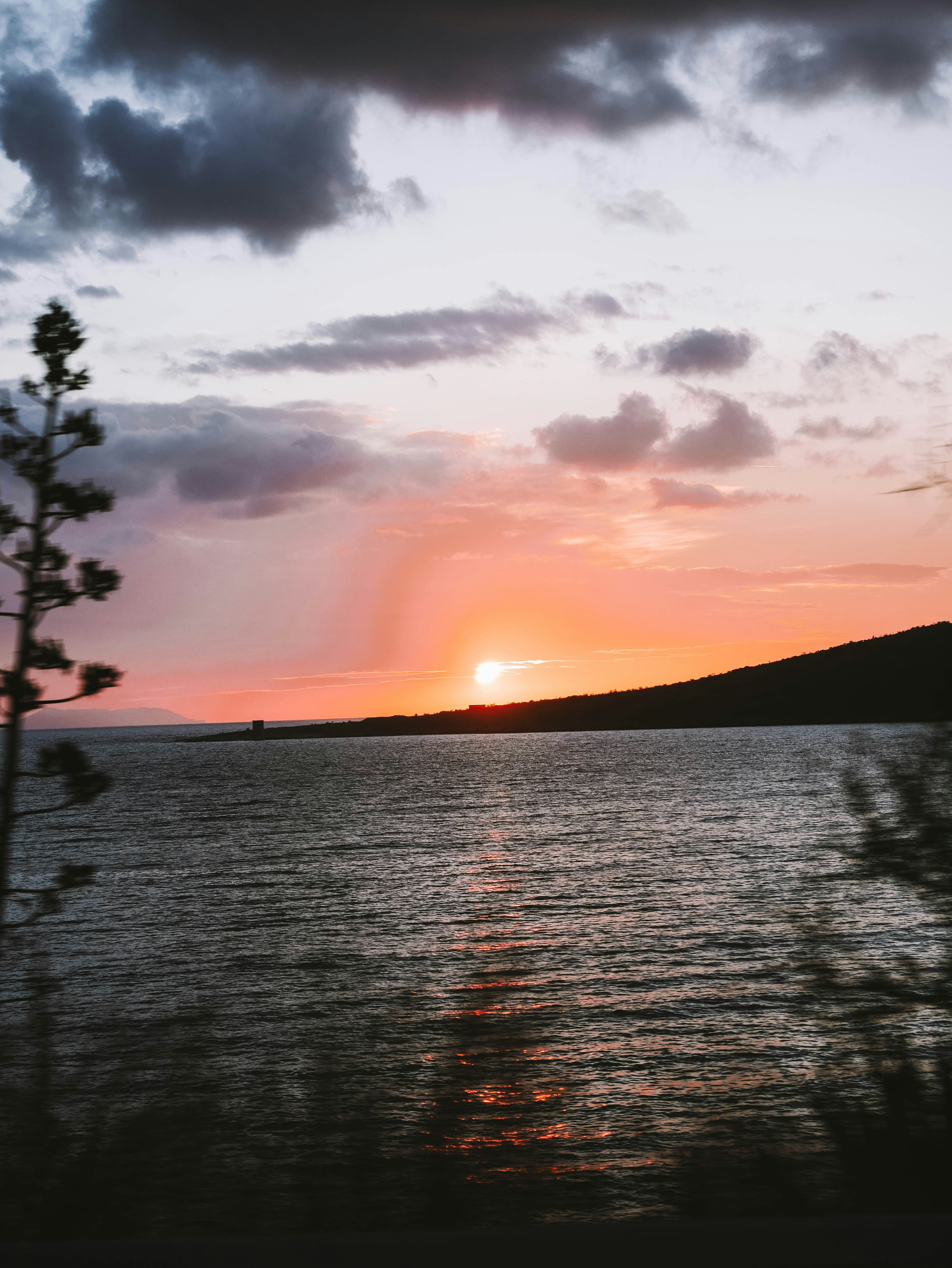 the sun is setting over a body of water