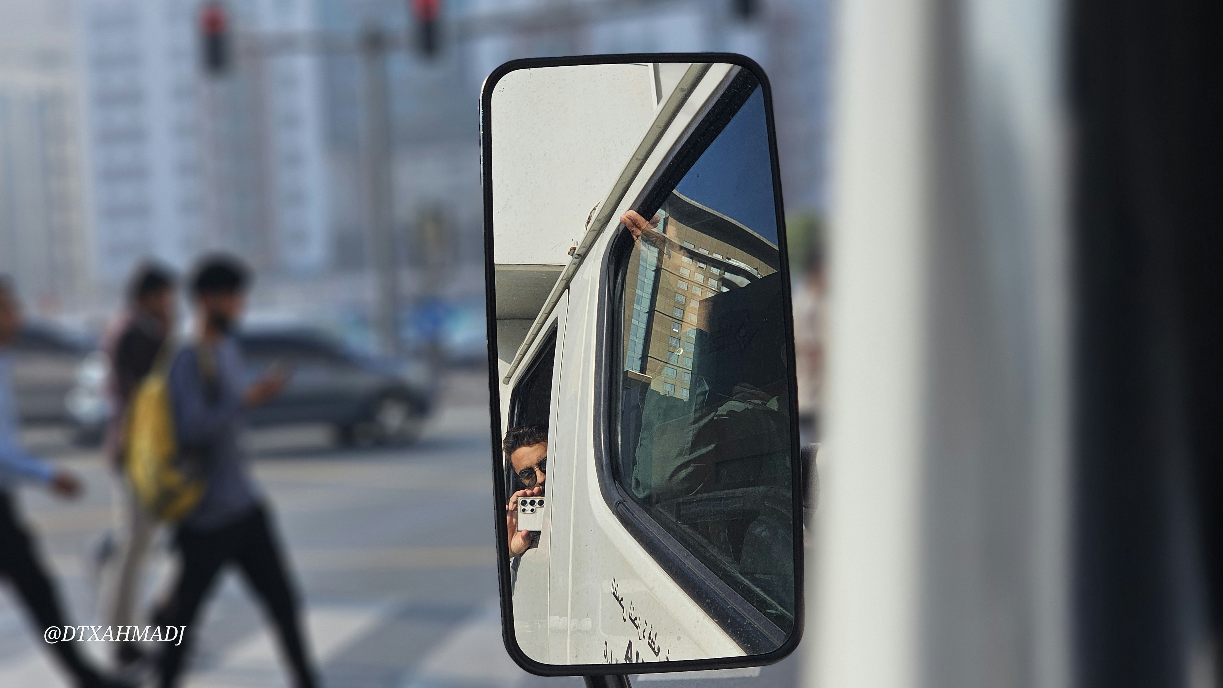 Glimmer in the Glass: A Street Moment Reflected in a Vertical Phone Screen