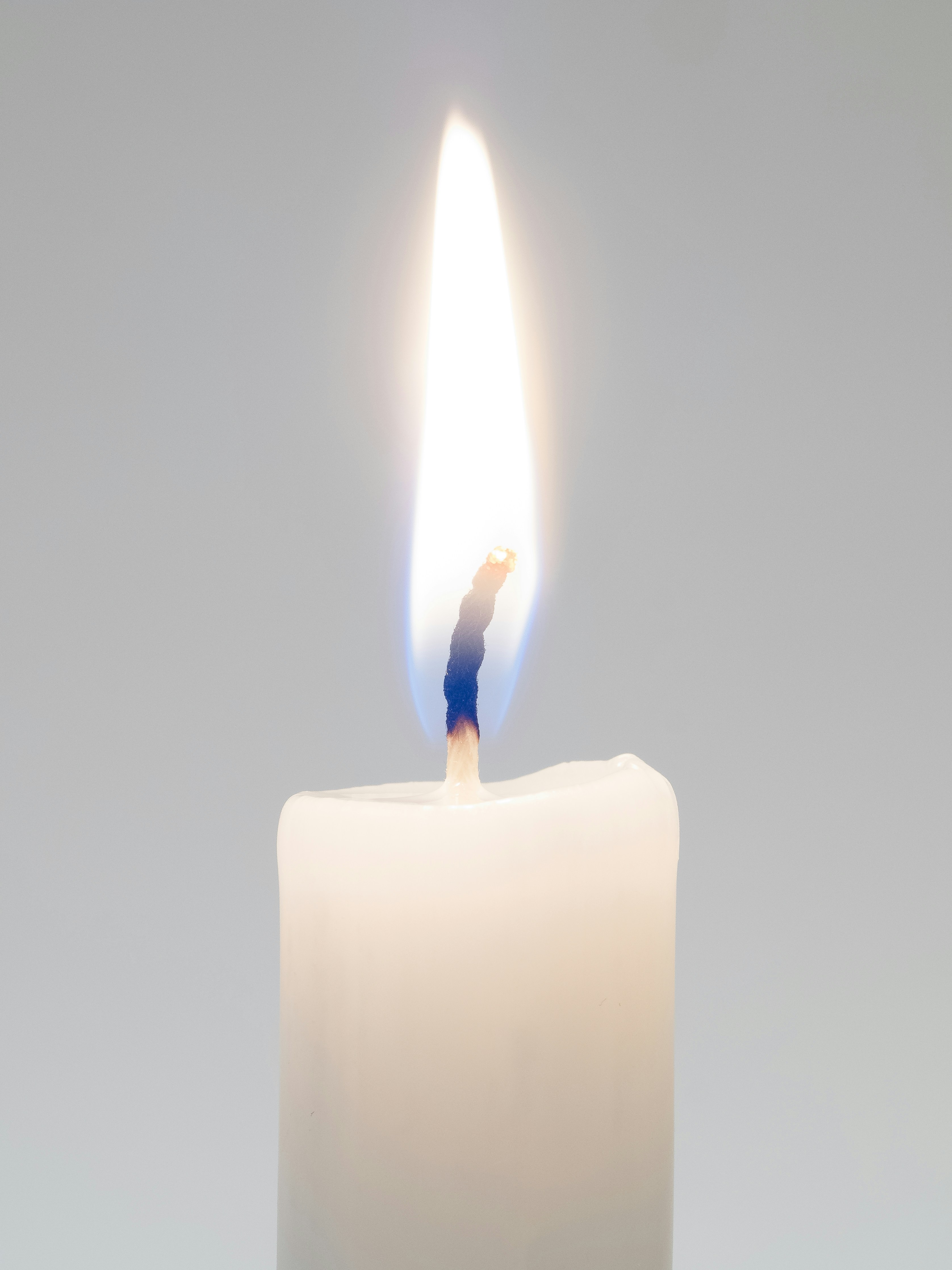 A candle with a lit candle stick sticking out of it photo – Free Candle ...