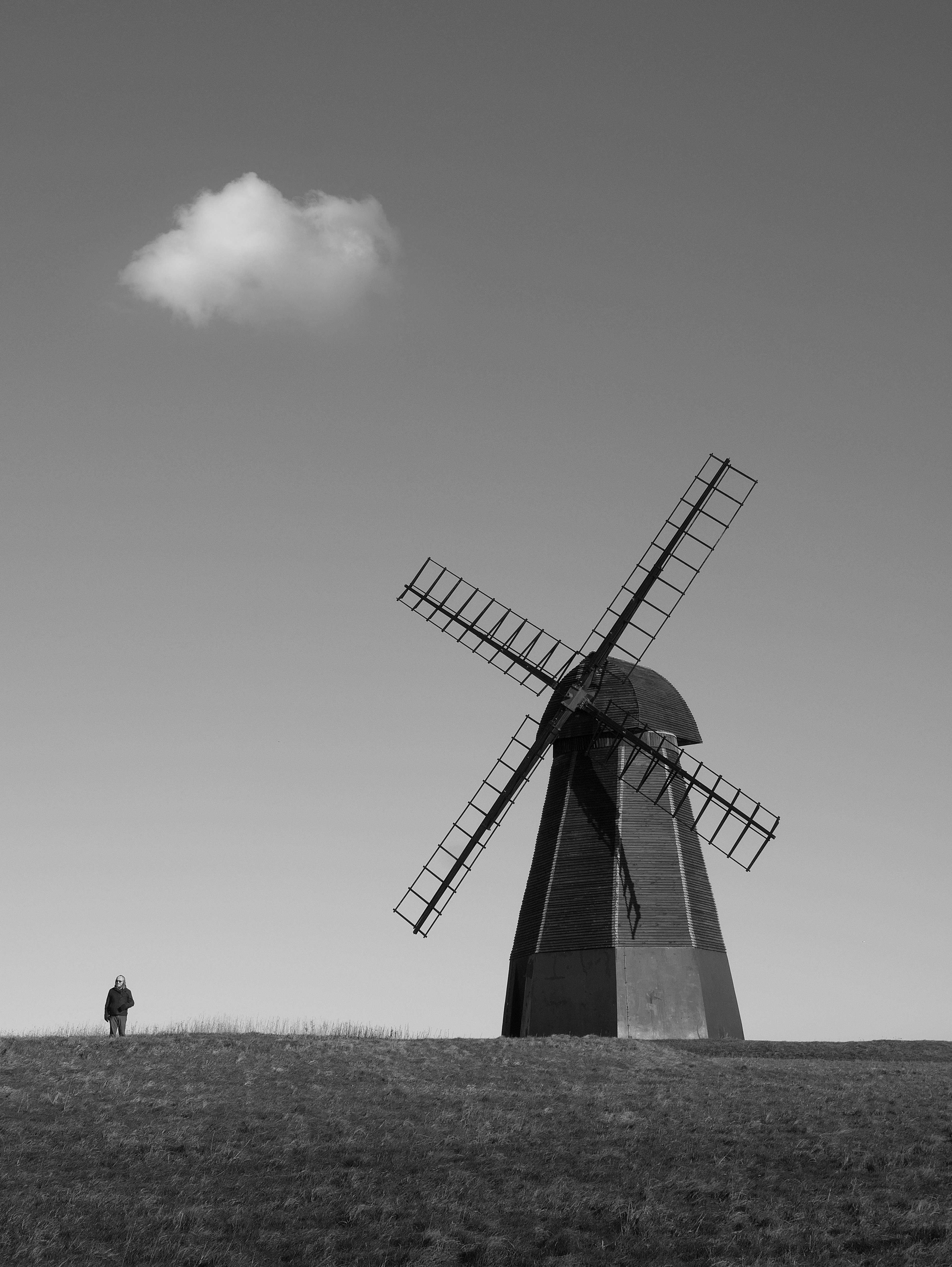Windswept Sentinel: The Lone Windmill on a Quiet Hill