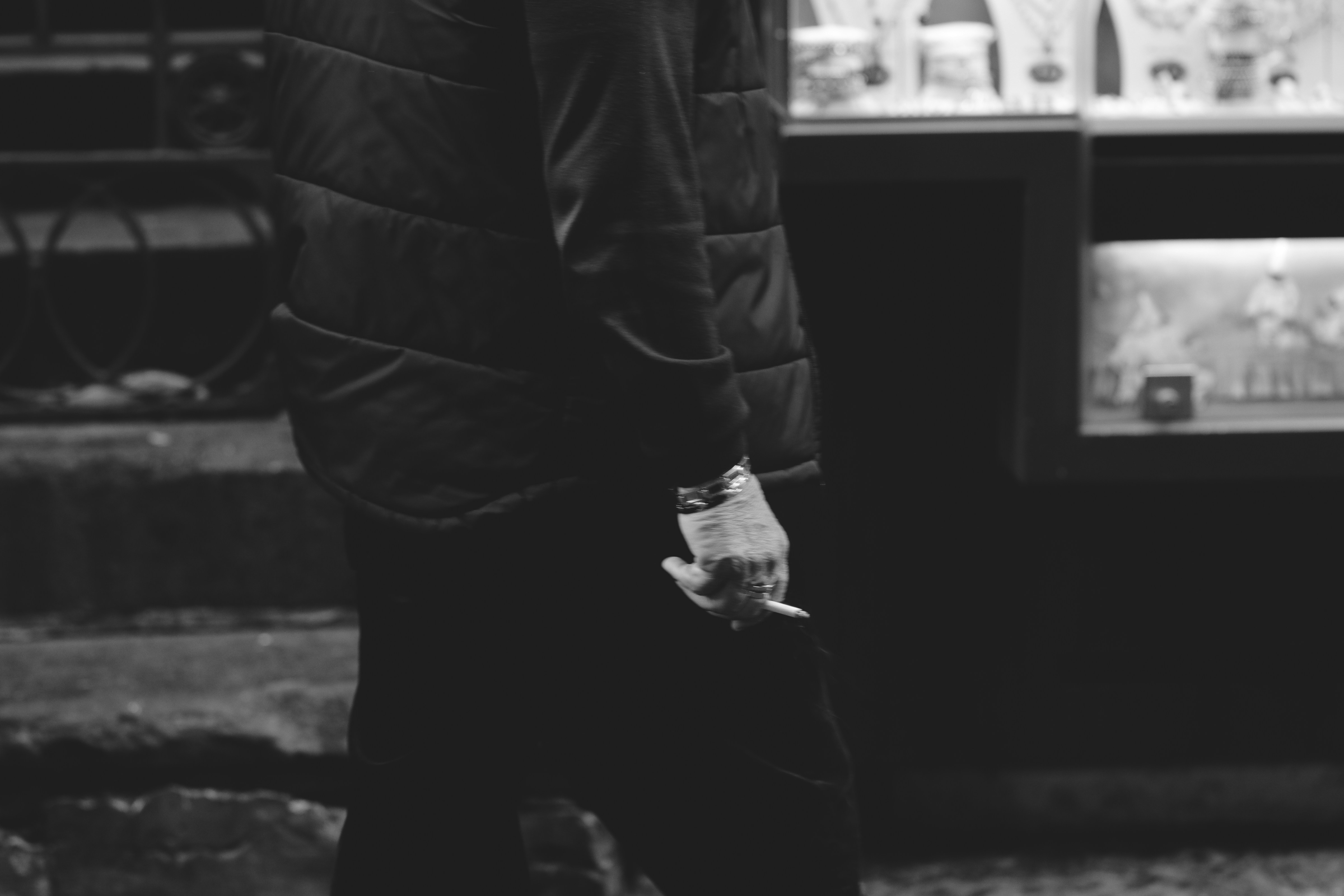 A man walking down a street next to a vending machine photo – Free ...