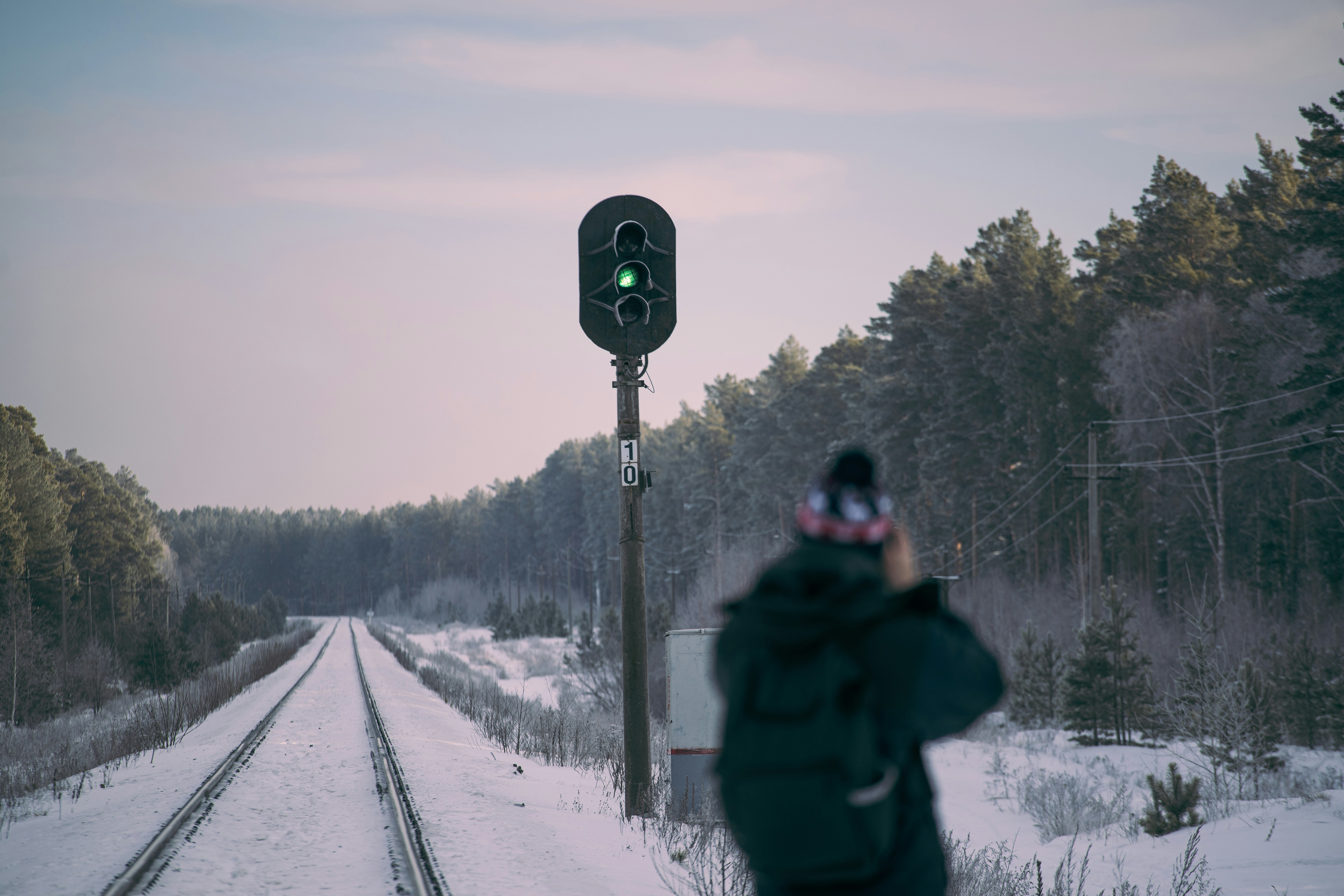 A person taking a picture of a train track photo – Free Image on Unsplash