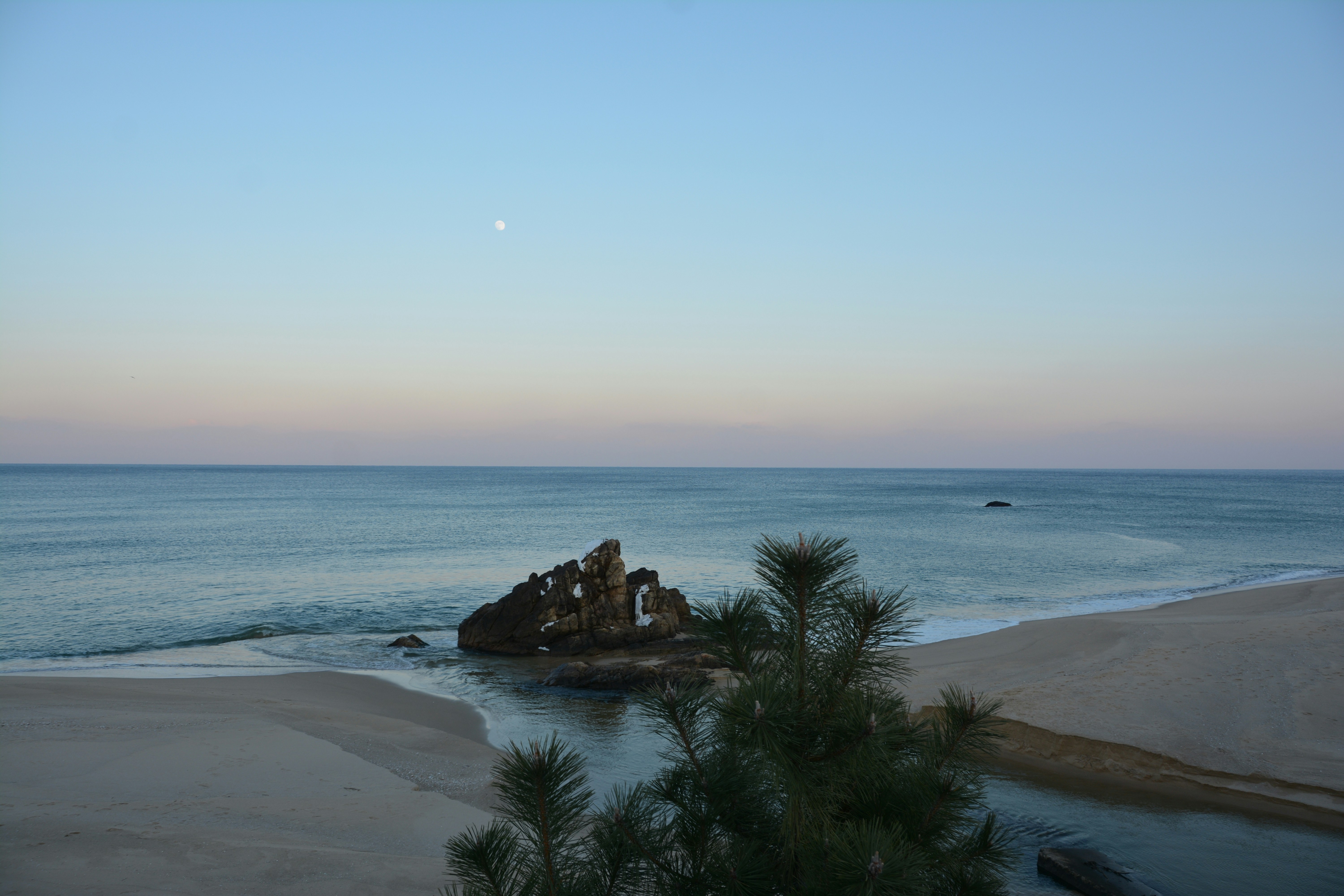Stone Sentinel at a Calm Coastal Twilight