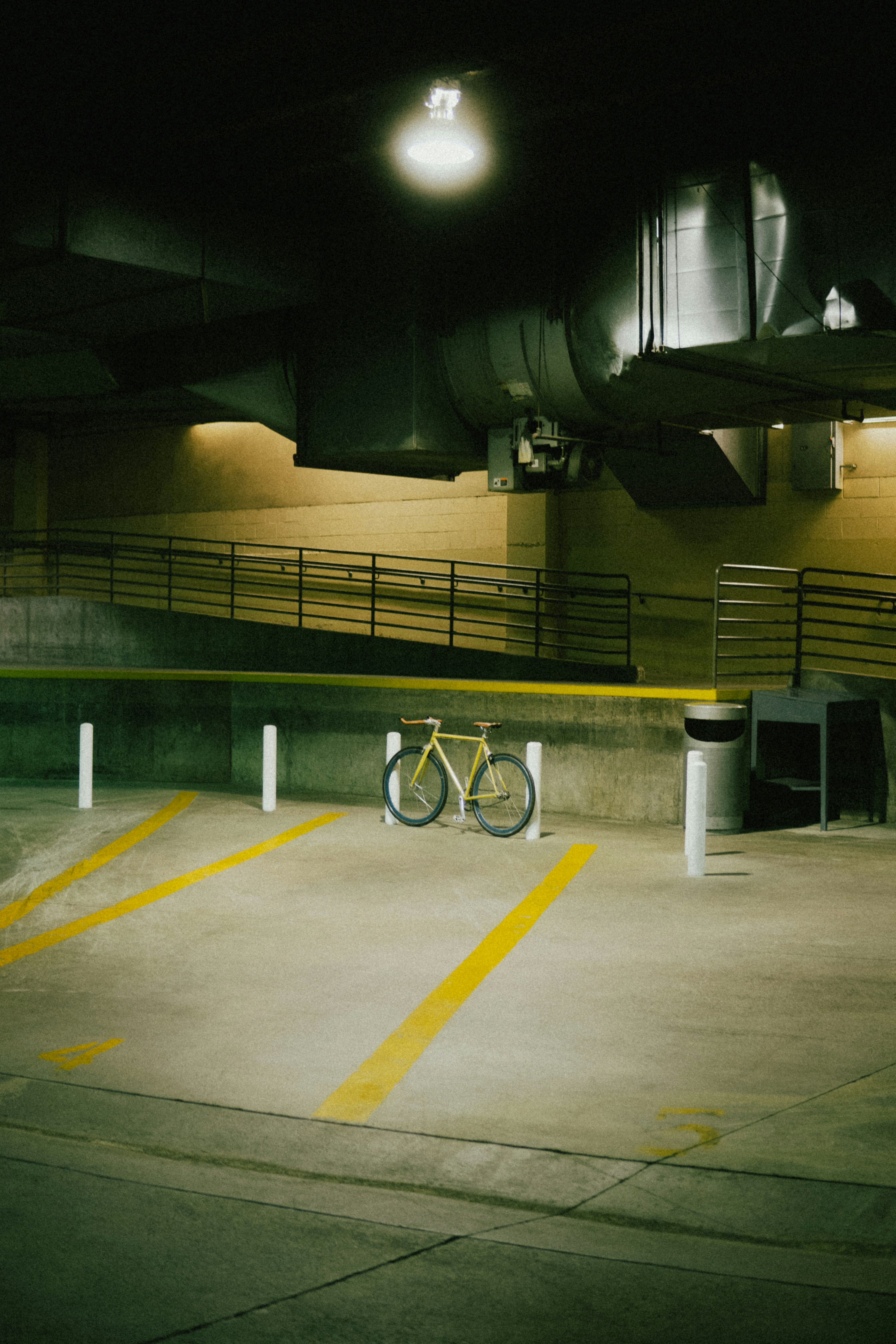 Lonely Yellow Bicycle Under Industrial Glow in an Underground Parking