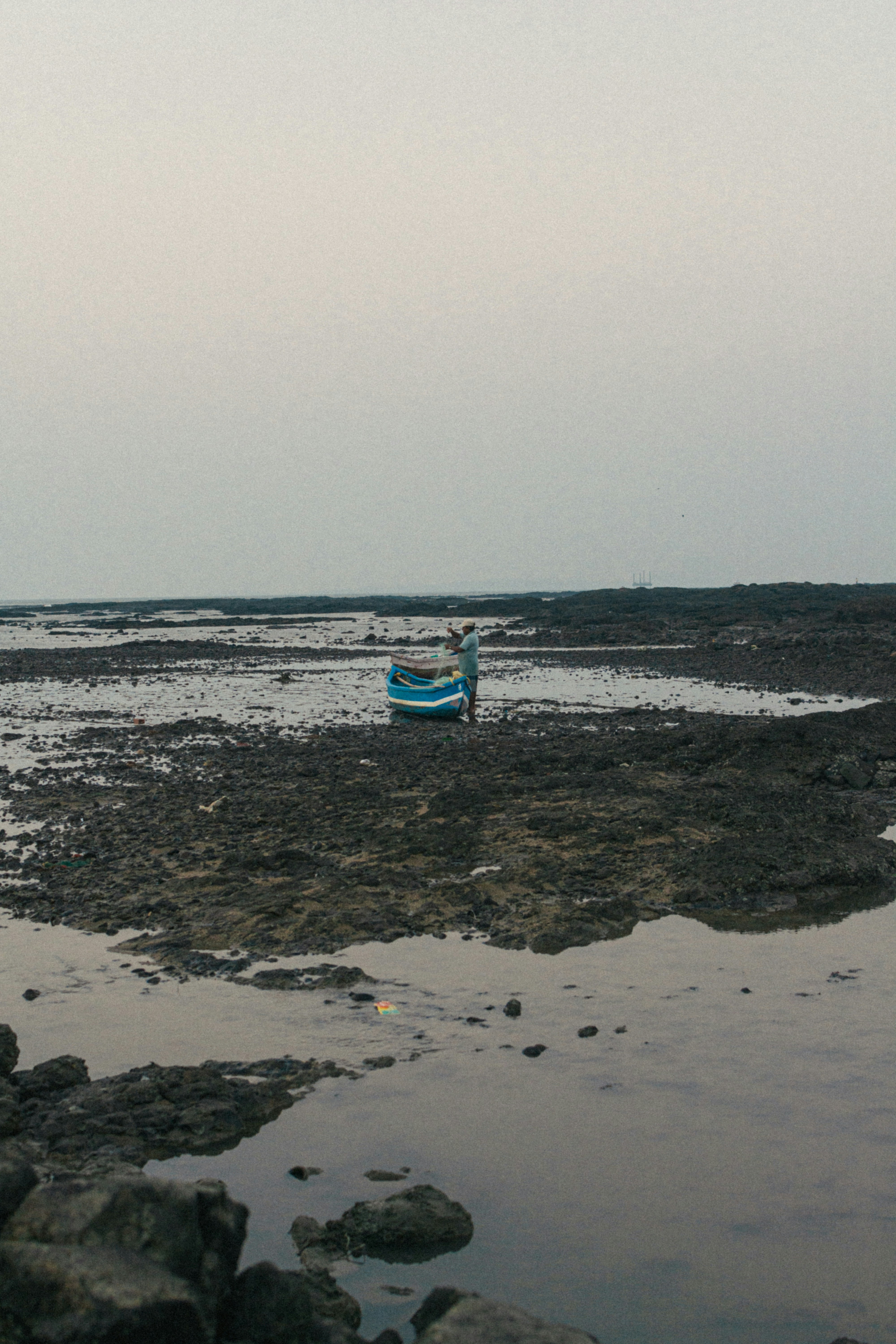 Blue Rowboat on Moonlit Mudflats at Dusk