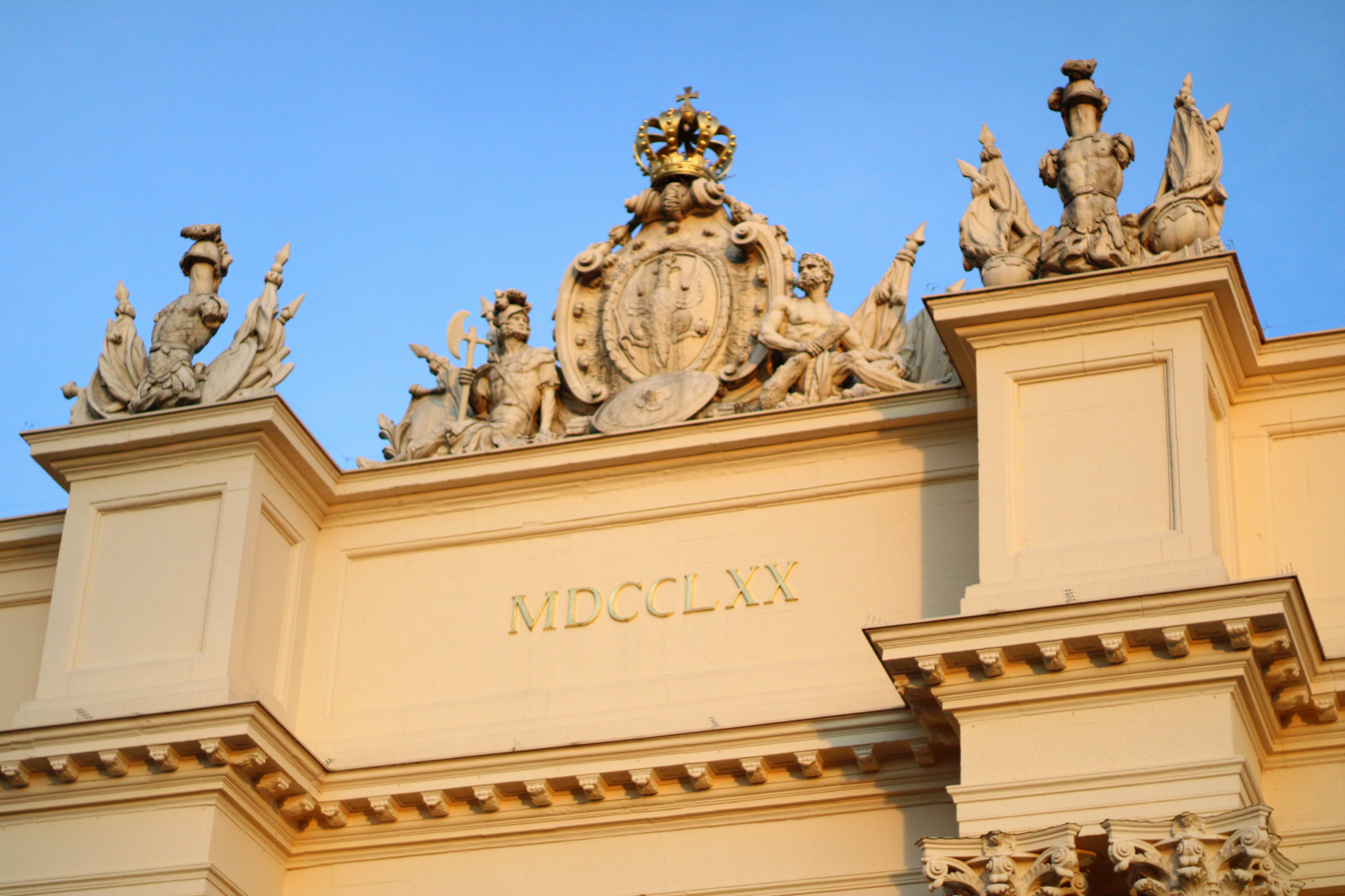 Crest of Time: The Sunlit Baroque Entrance with Regal Statues