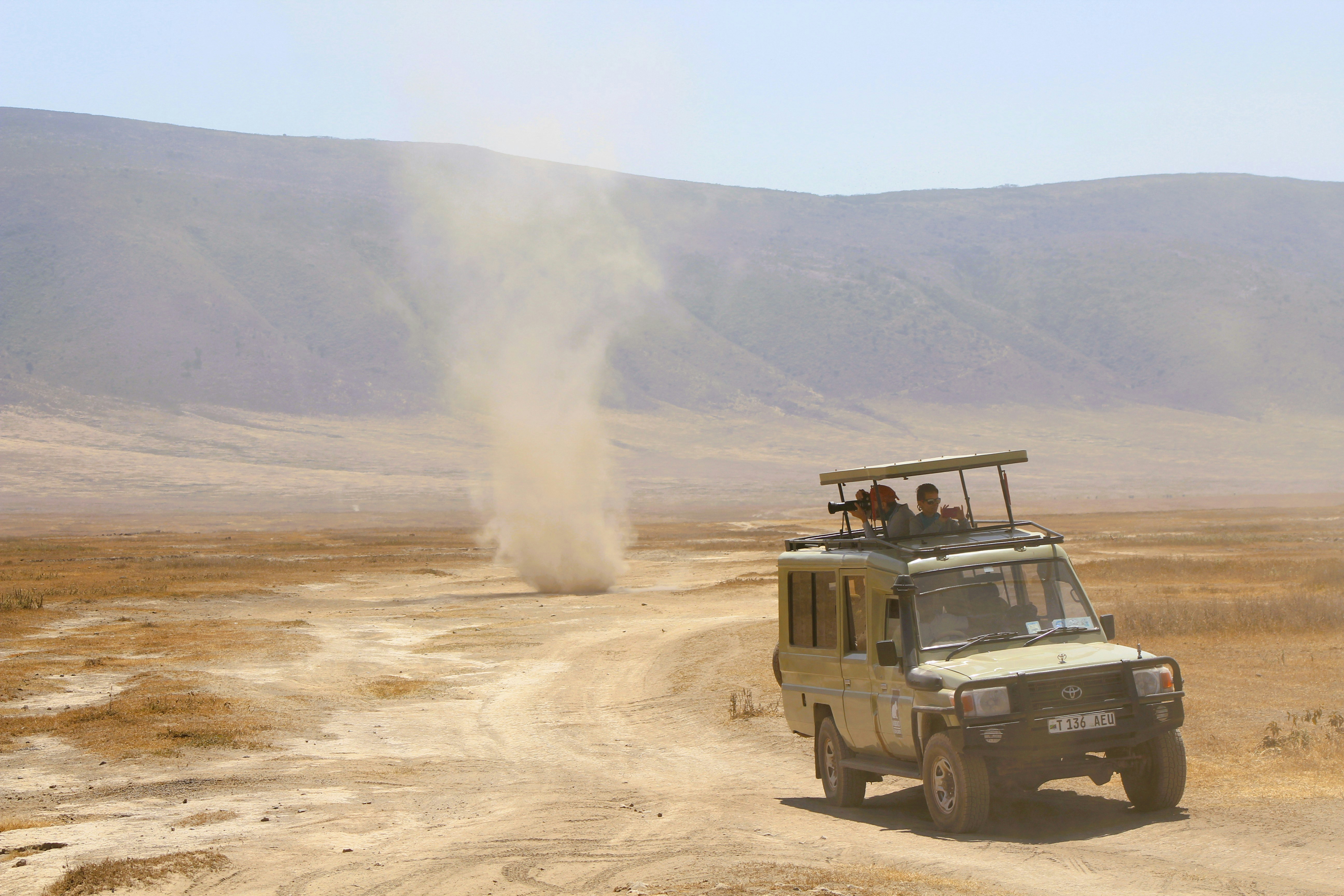 Dust Sprint: Rugged Safari Van Charges a Wind-Swept Desert Road