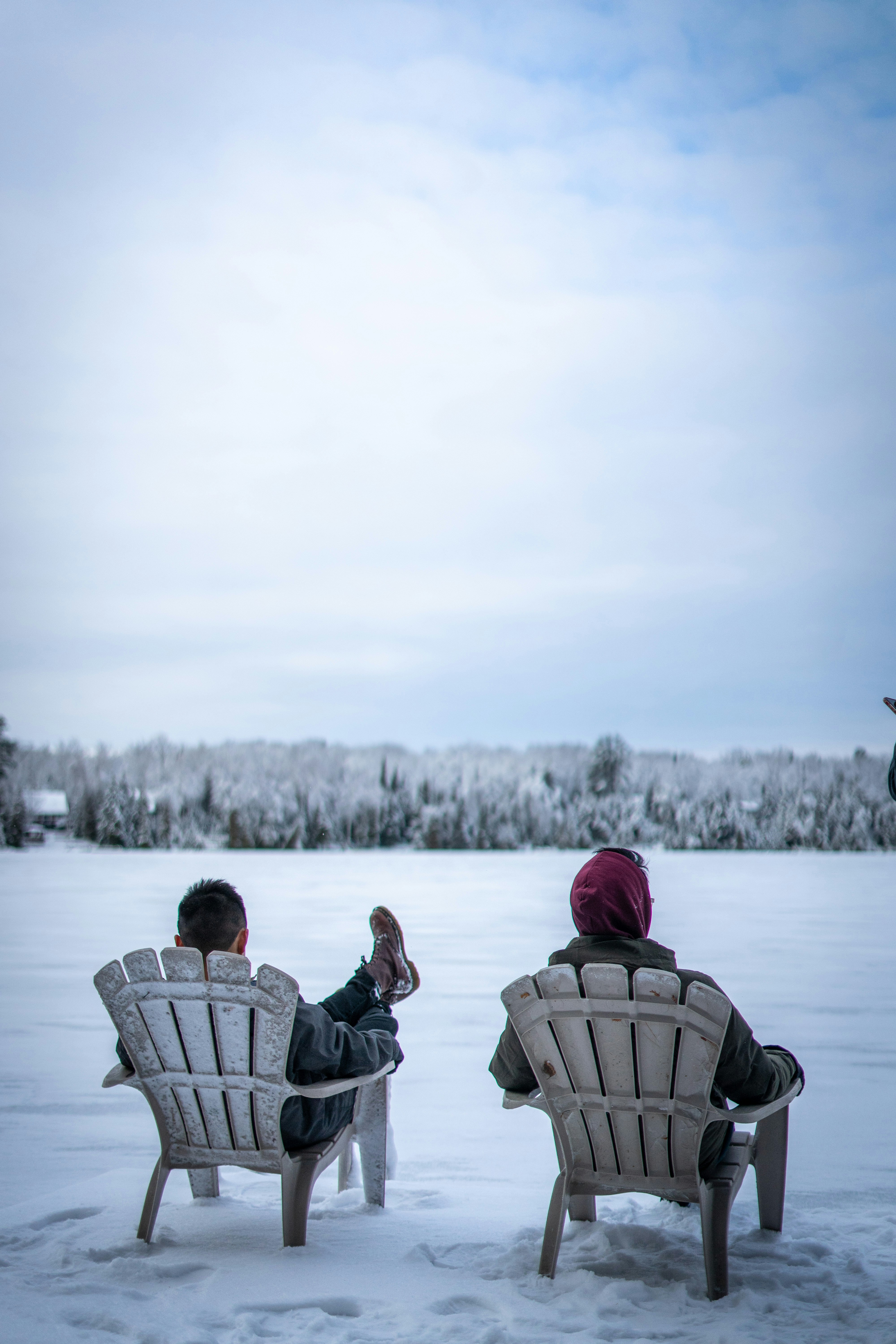 Two Chairs Facing a Frozen Lake: A Quiet Winter Moment