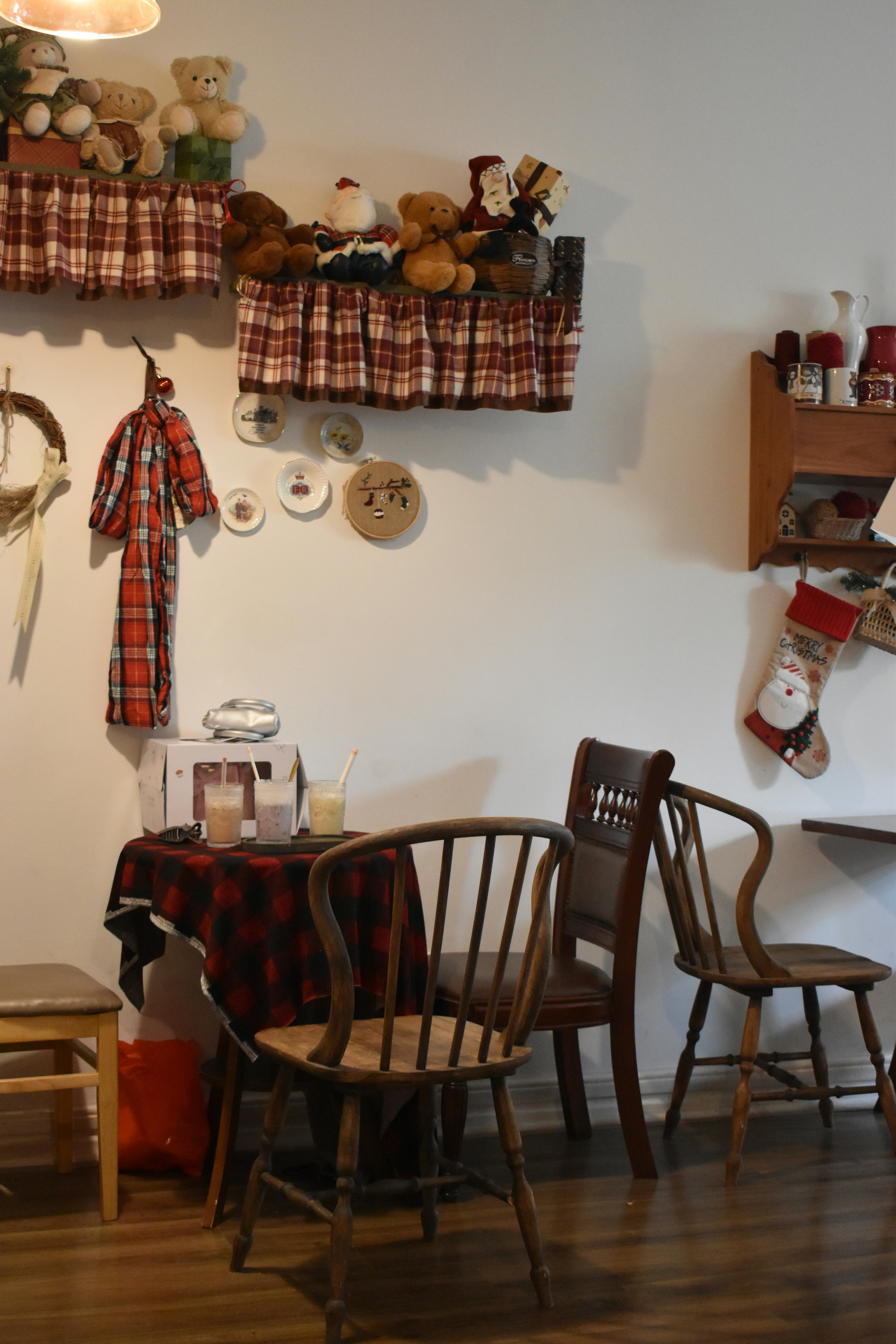 Teddy-Topped Shelf Over a Plaid Table: A Cozy Café Corner