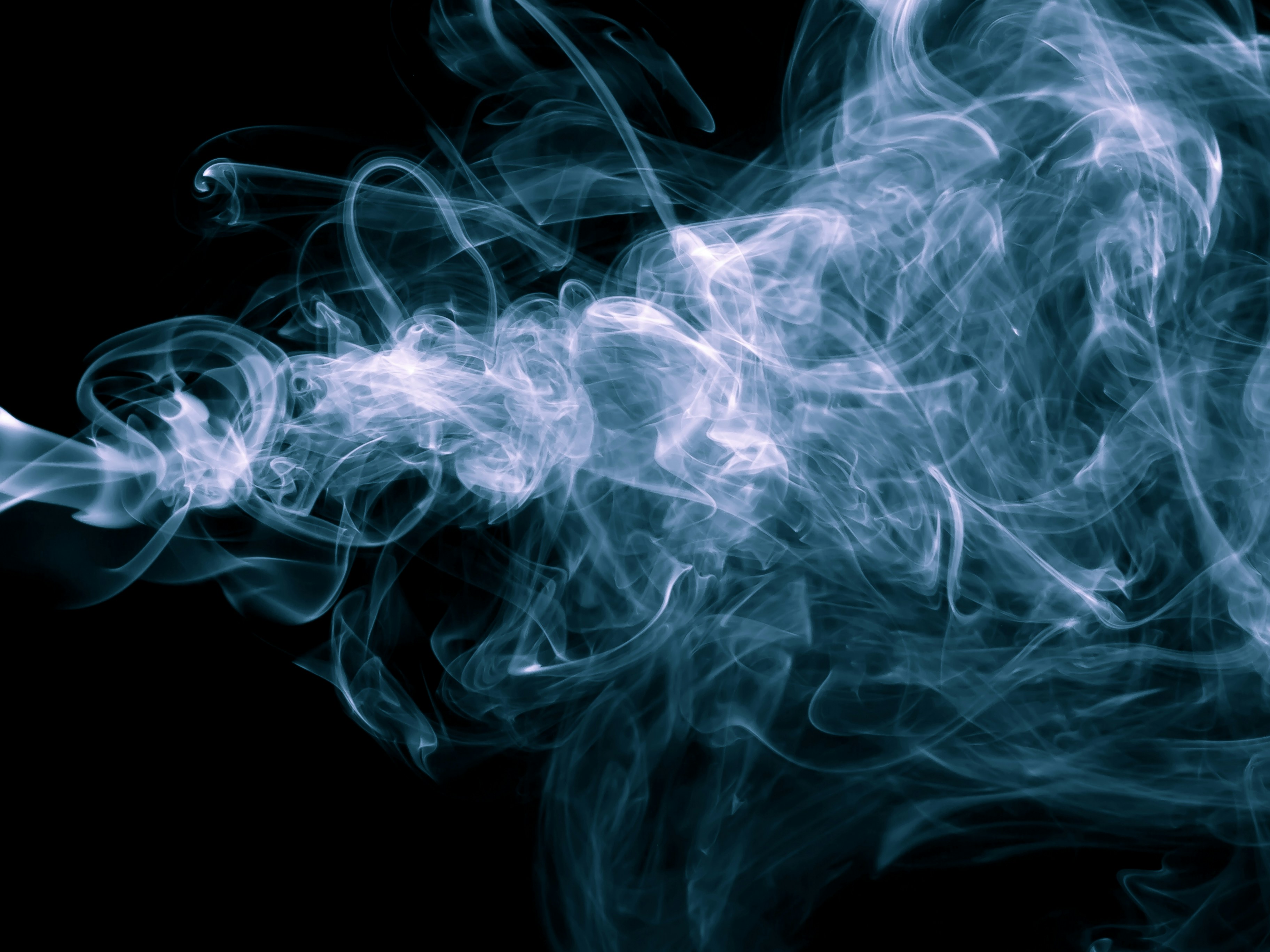 Electric Blue Smoke Ribbon Drifts Across a Midnight Black Canvas
