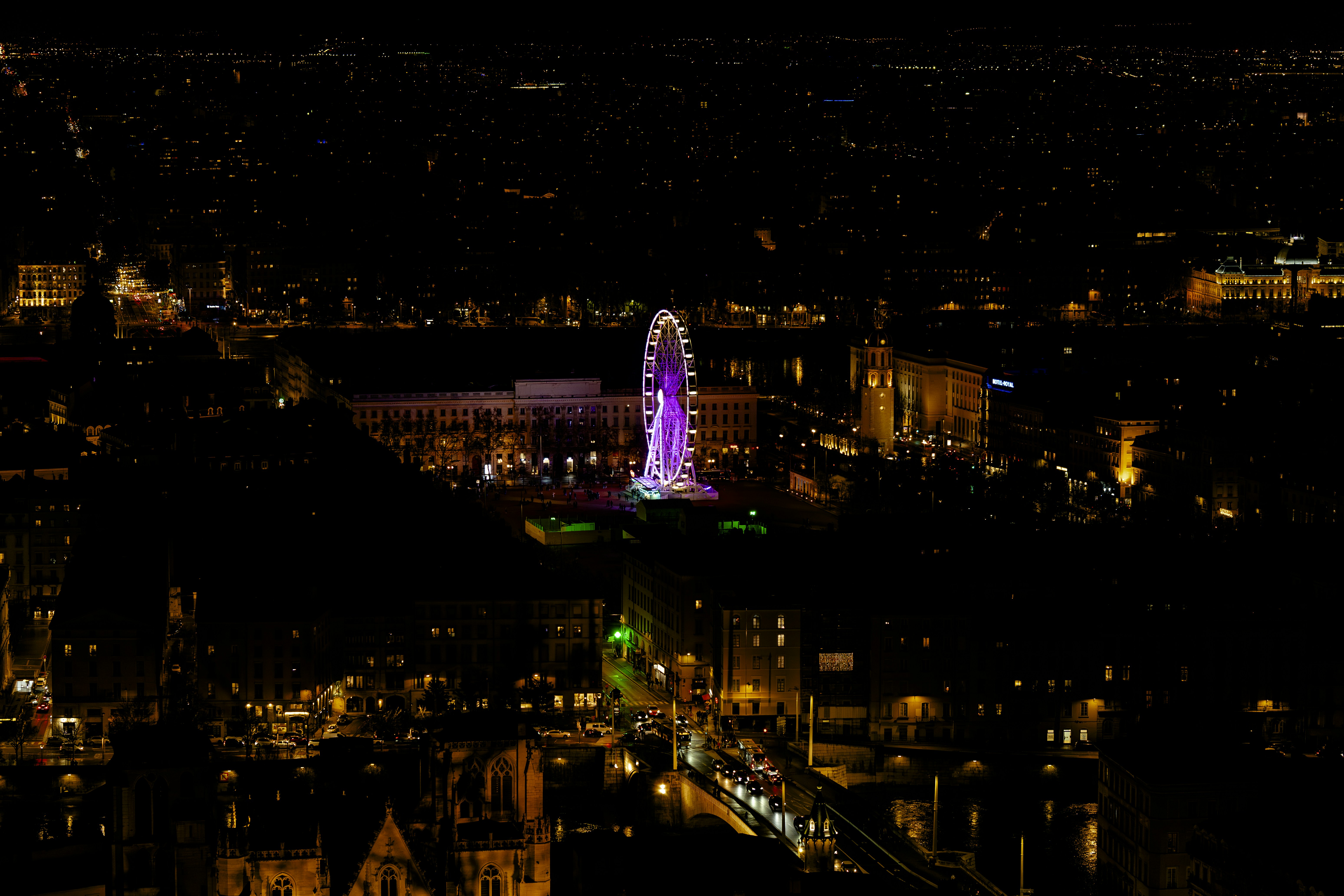 Midnight Orbit: The Purple Ferris Wheel Illuminates a Silent City