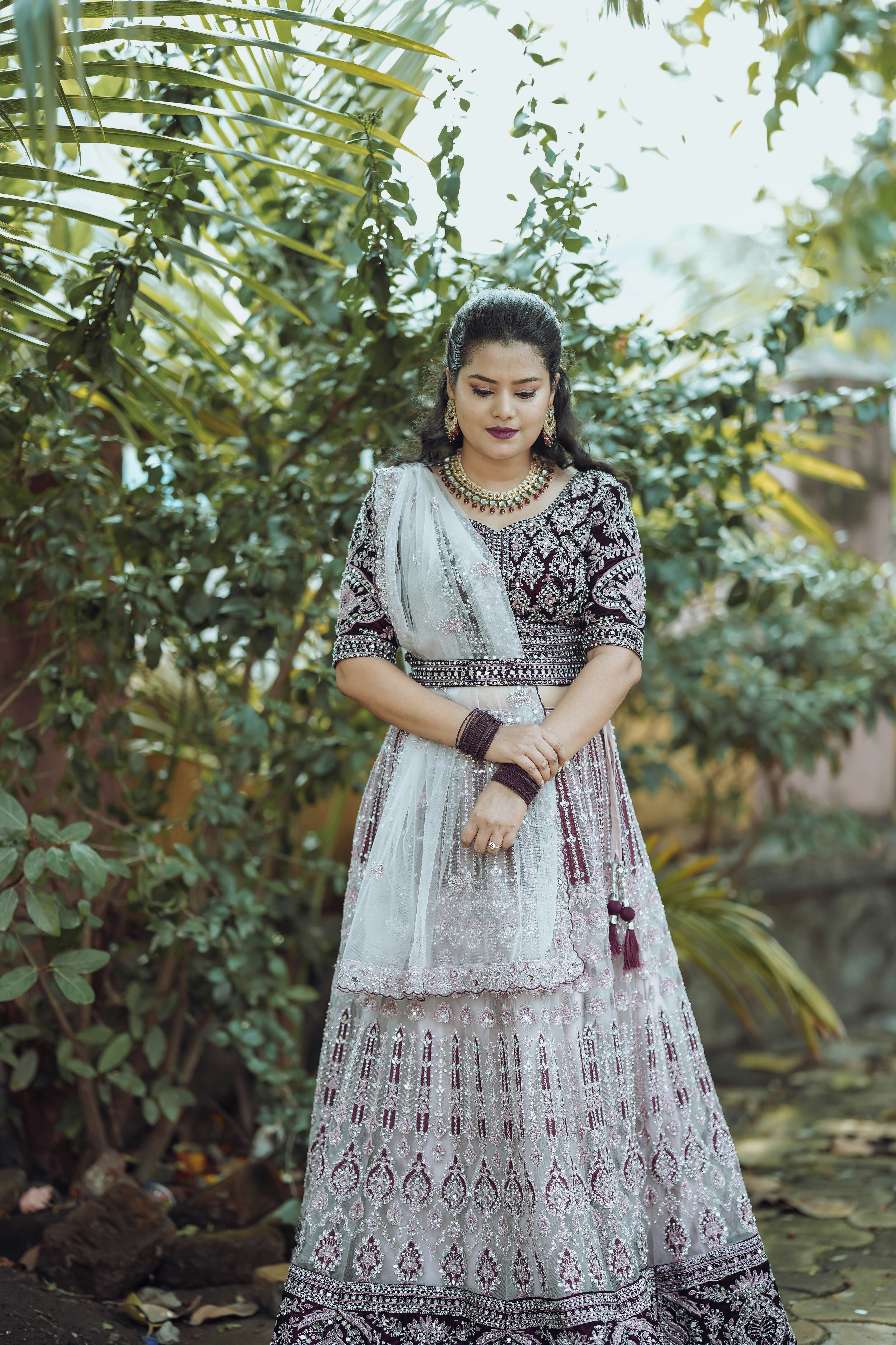 A woman in a white dress standing in front of a tree photo – Free Woman ...