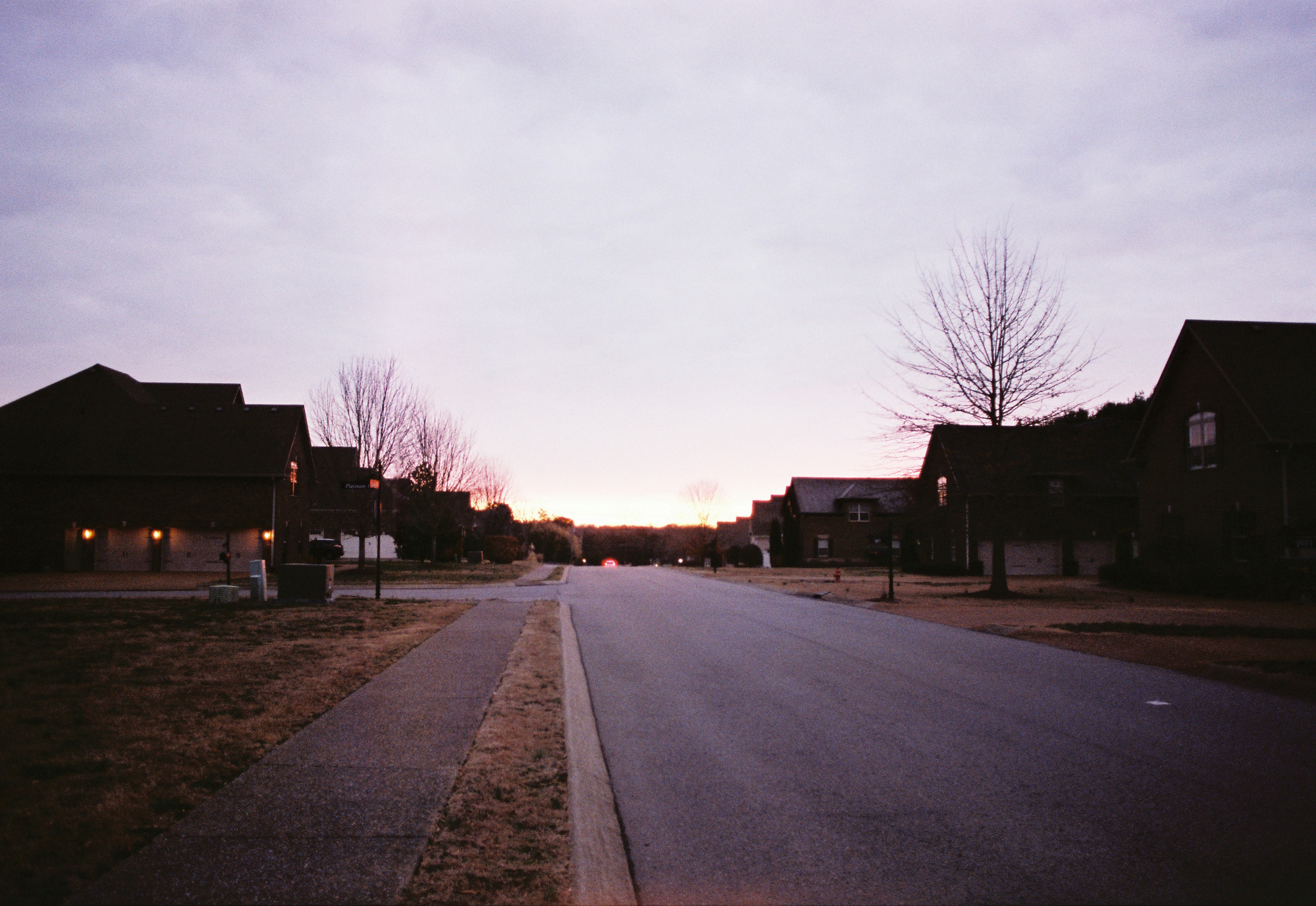 An empty street with houses in the background photo – Free Car Image on ...