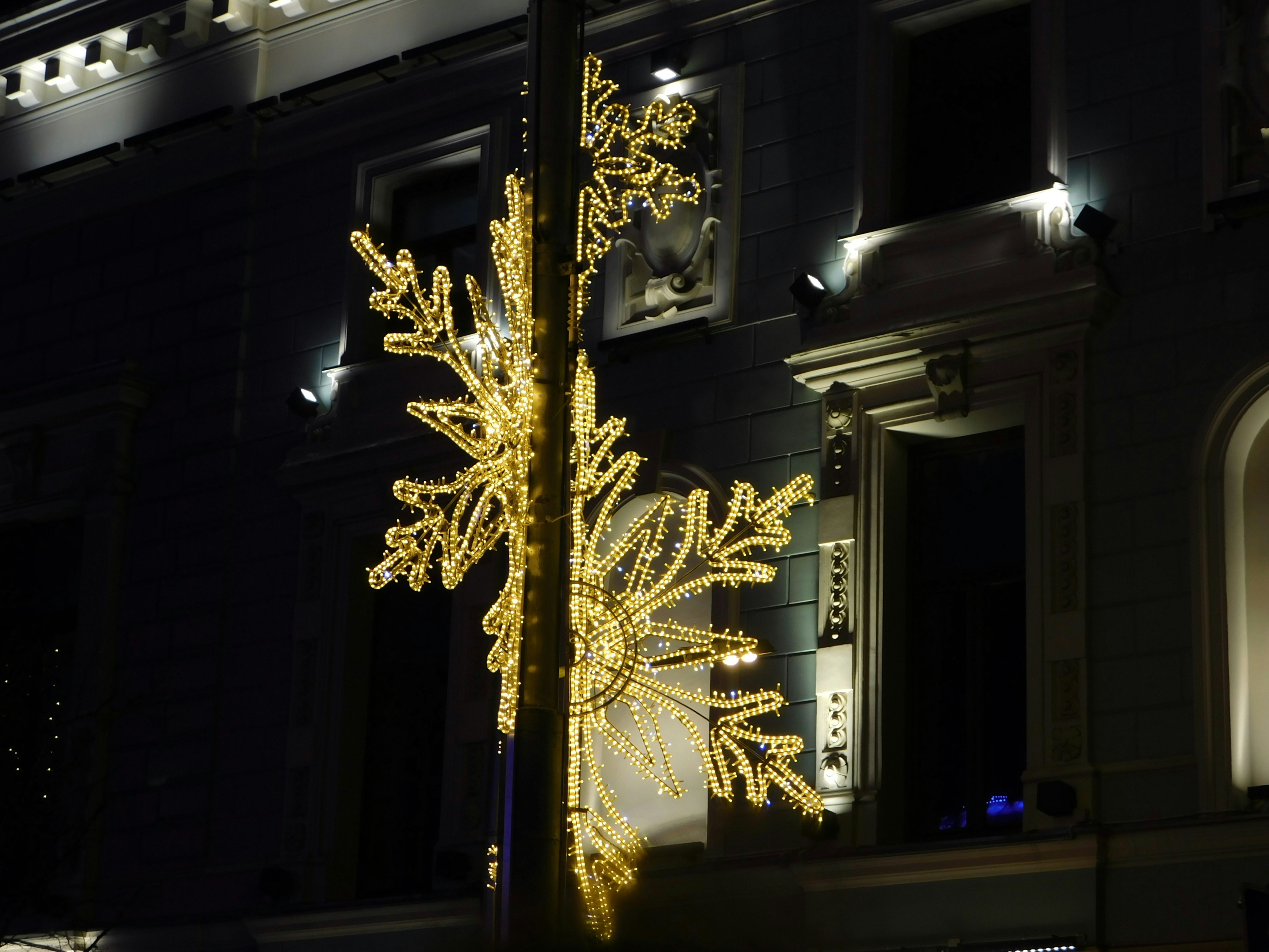 A lighted snowflake on a pole in front of a building photo – Free ...