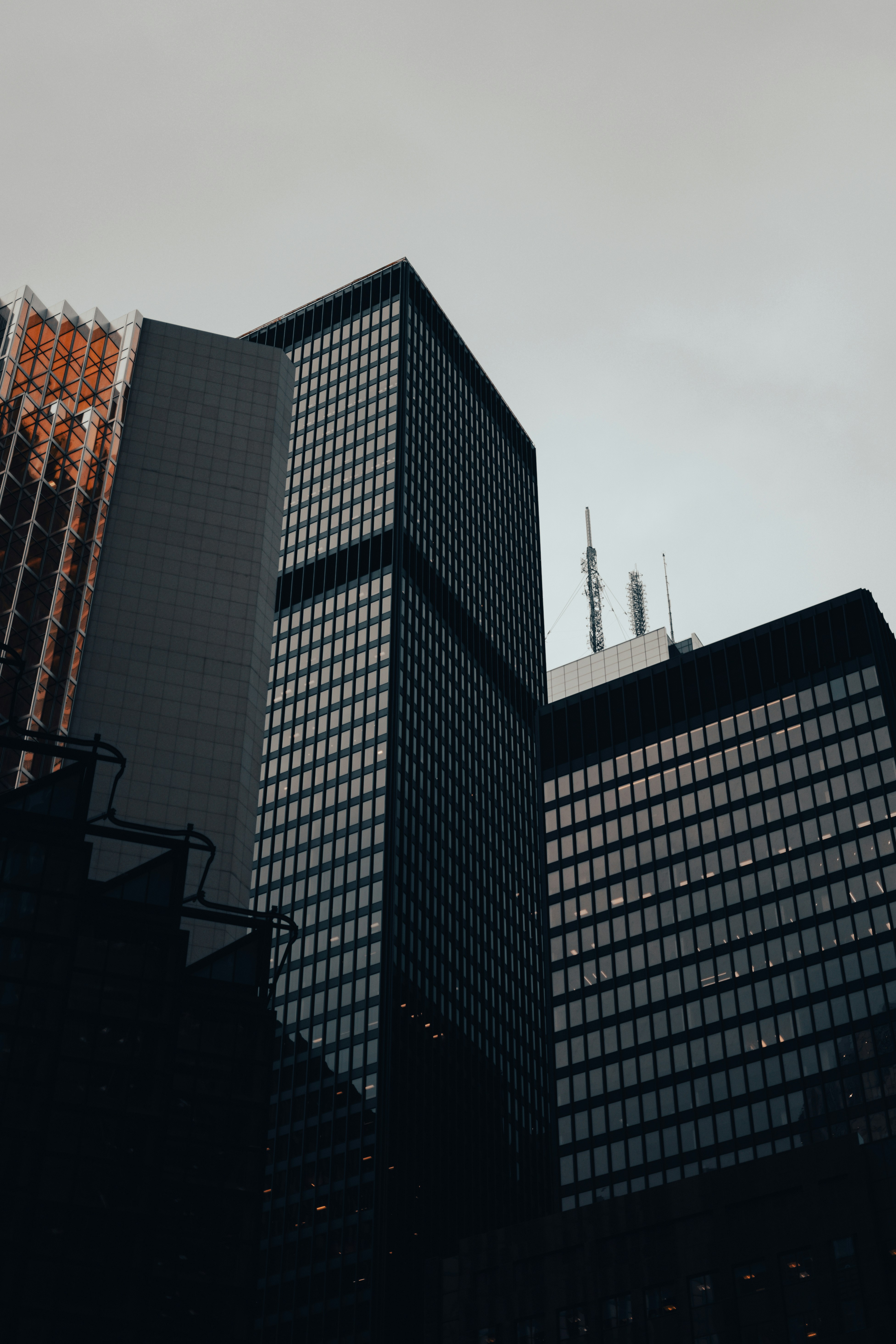 A couple of tall buildings sitting next to each other photo – Free ...