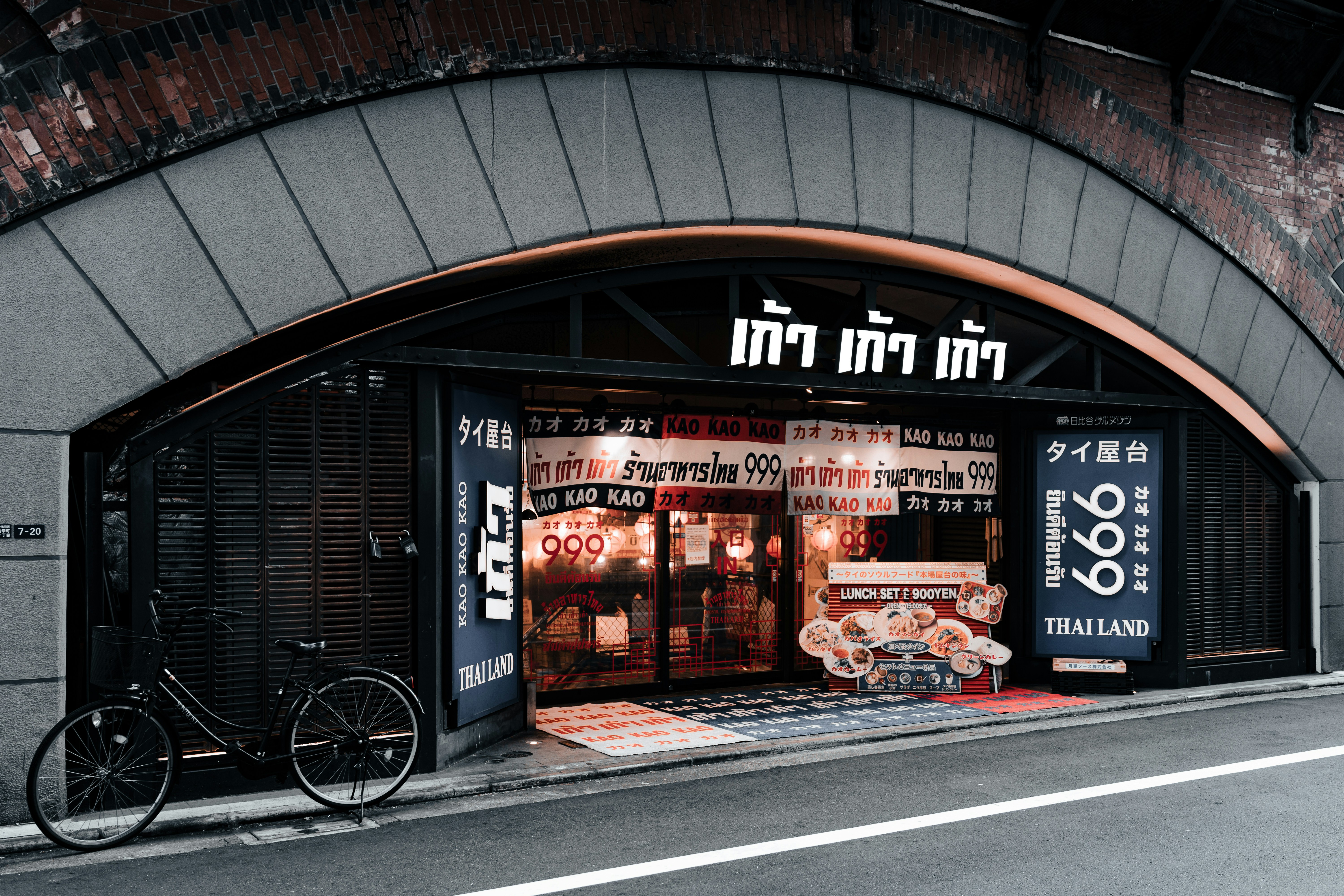 Under the Archway Neon: A Bangkok shopfront glows at dusk