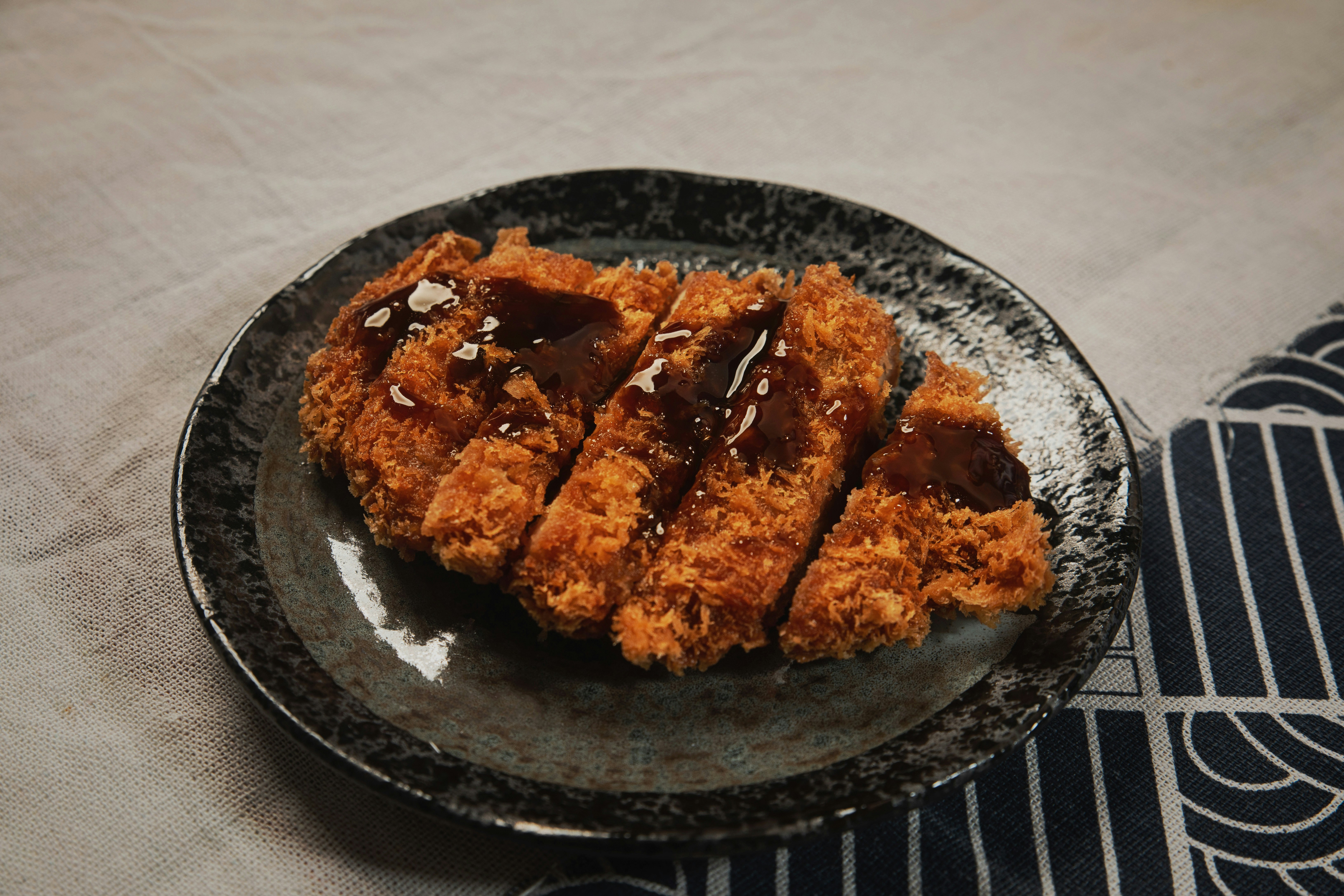 Crisped Katsu Slices with Soy Glaze on a Quiet Table