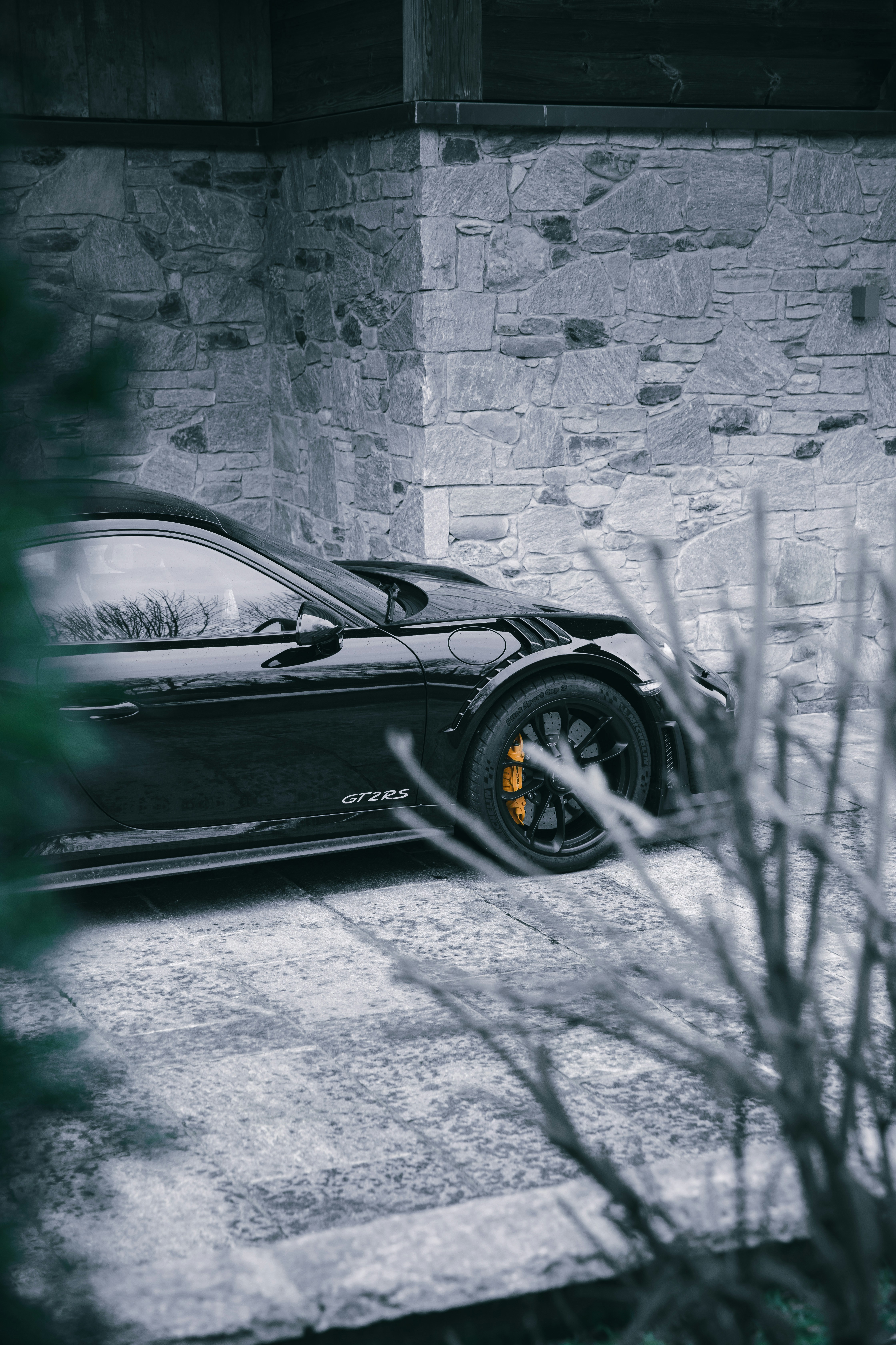A black sports car parked in front of a stone building photo – Free Car ...