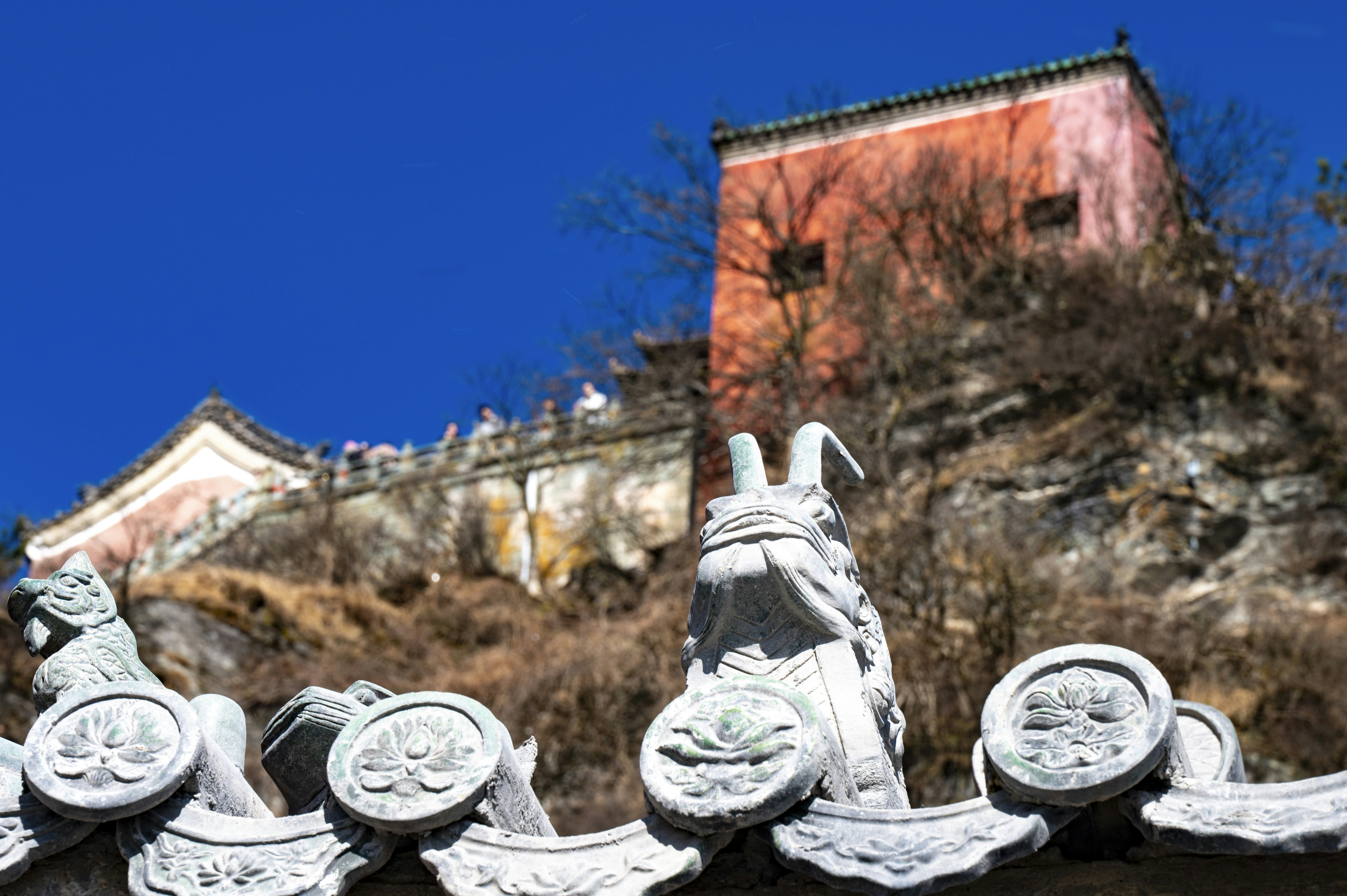 Stone Dragons Guard the Roofline Under a Blue Sky