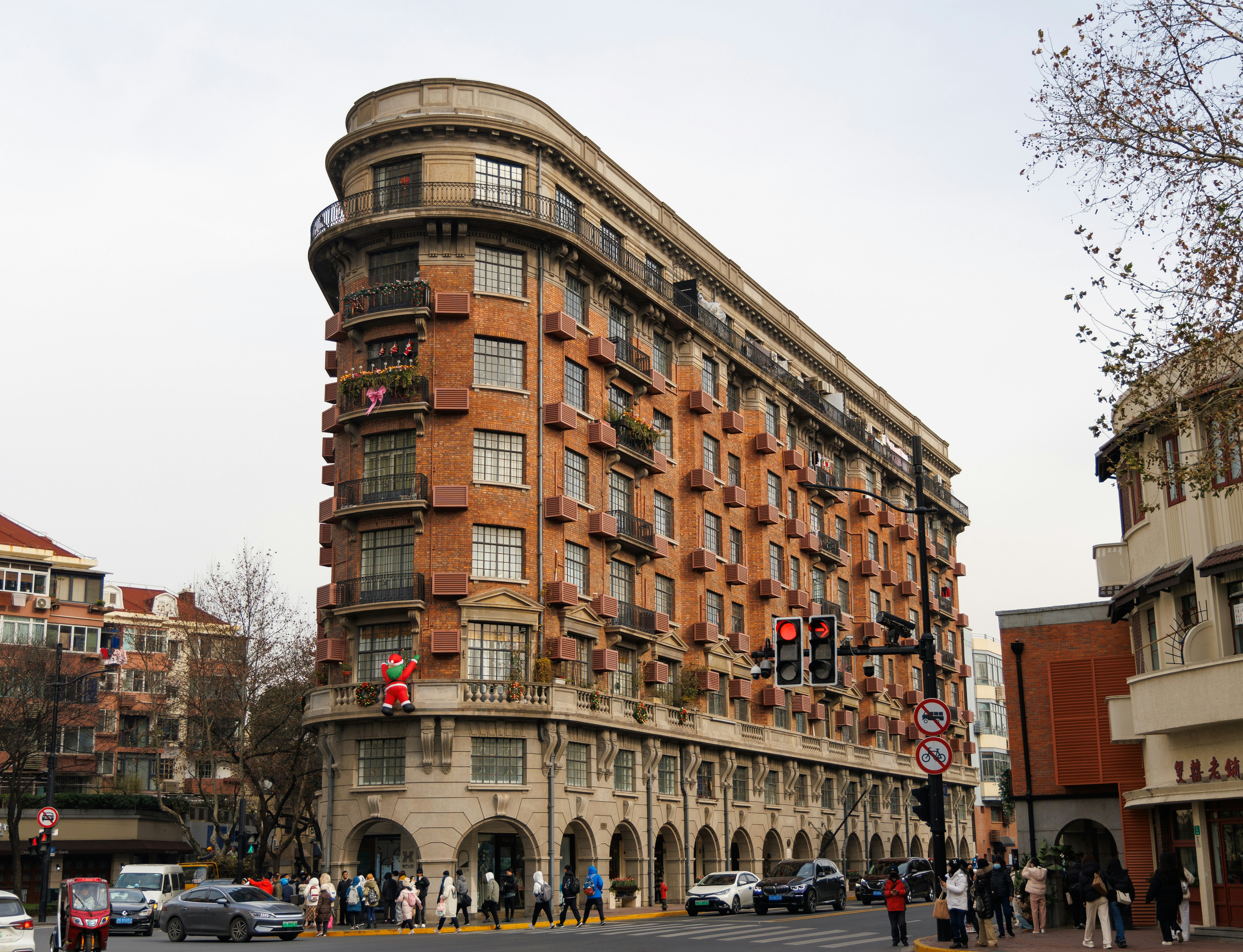 The Wukang Building is one of the most famous structures in Shanghai. It's a delightful place to stroll, relax in the surrounding coffee shops, and capture some Instagram-worthy pictures. Whether you're into street photography or just want to soak in the atmosphere, the historic apartment building, dating back to 1924, is a must-visit. Situated on the corner of Wukang Road, it offers a unique glimpse into Shanghai's past. | 23 December 2023 | a very tall building with lots of windows