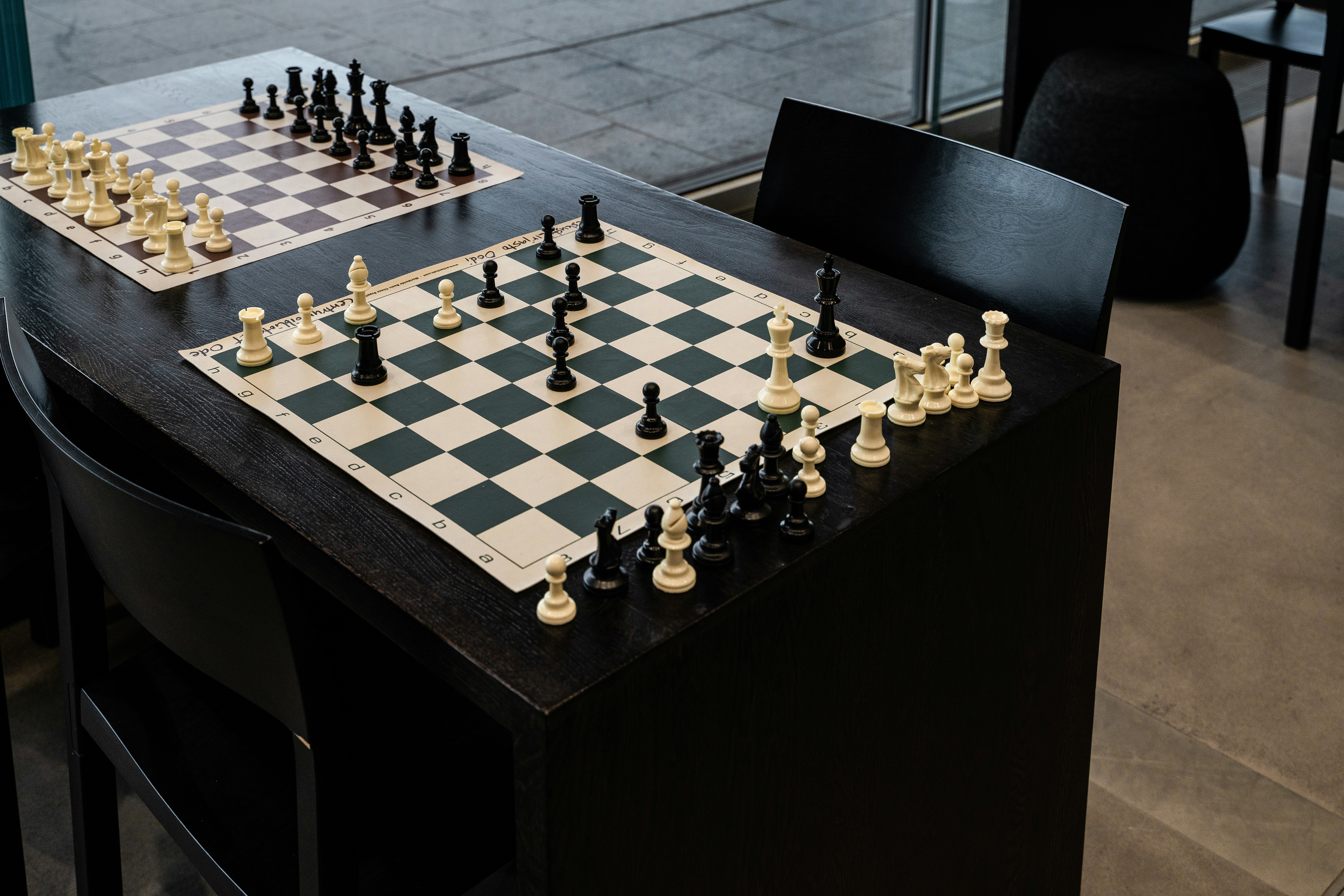A black and white chess set up on a table photo – Free Grey Image on ...