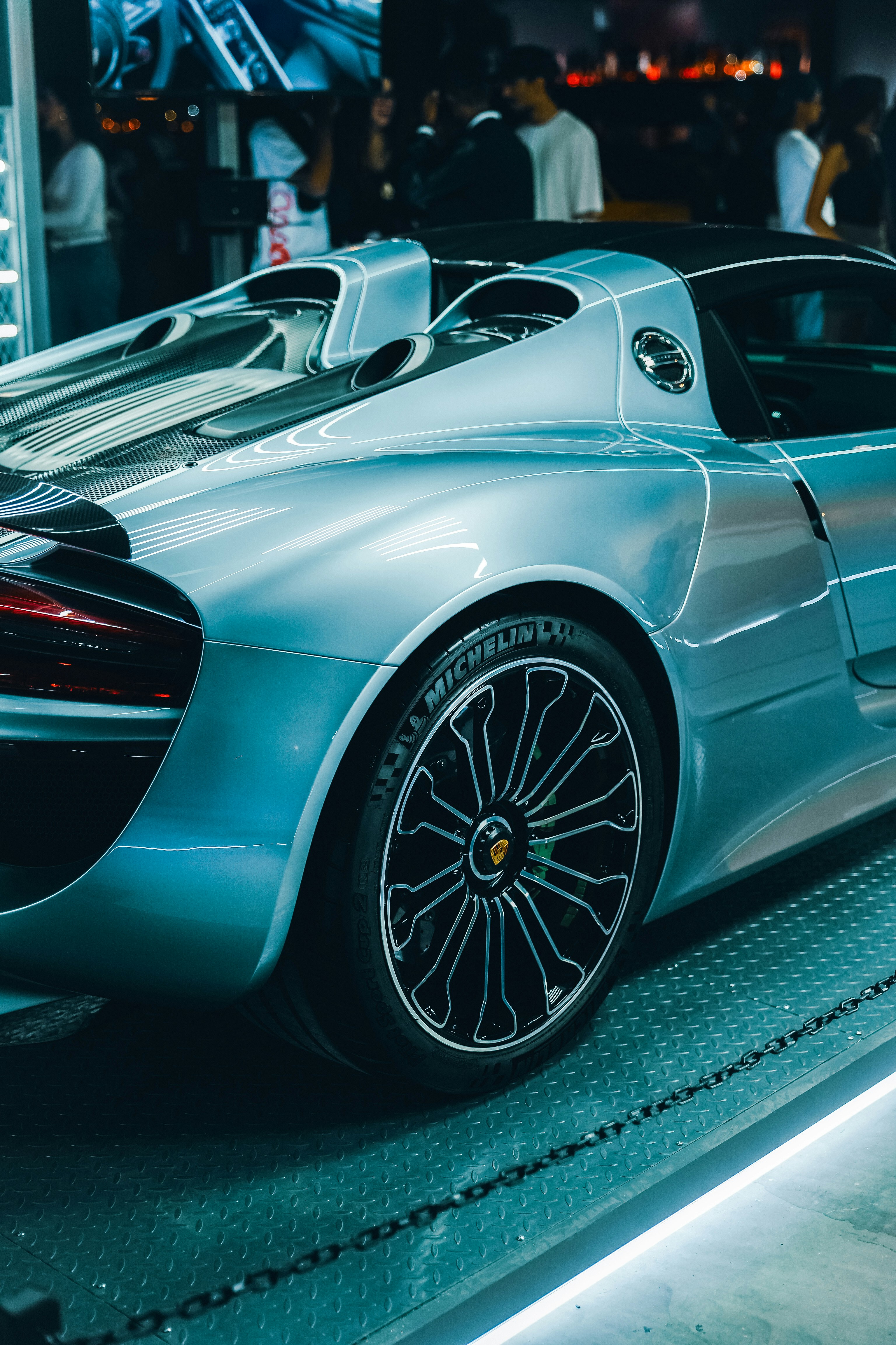 Azure Velocity: A Porsche on Neon Show Floor