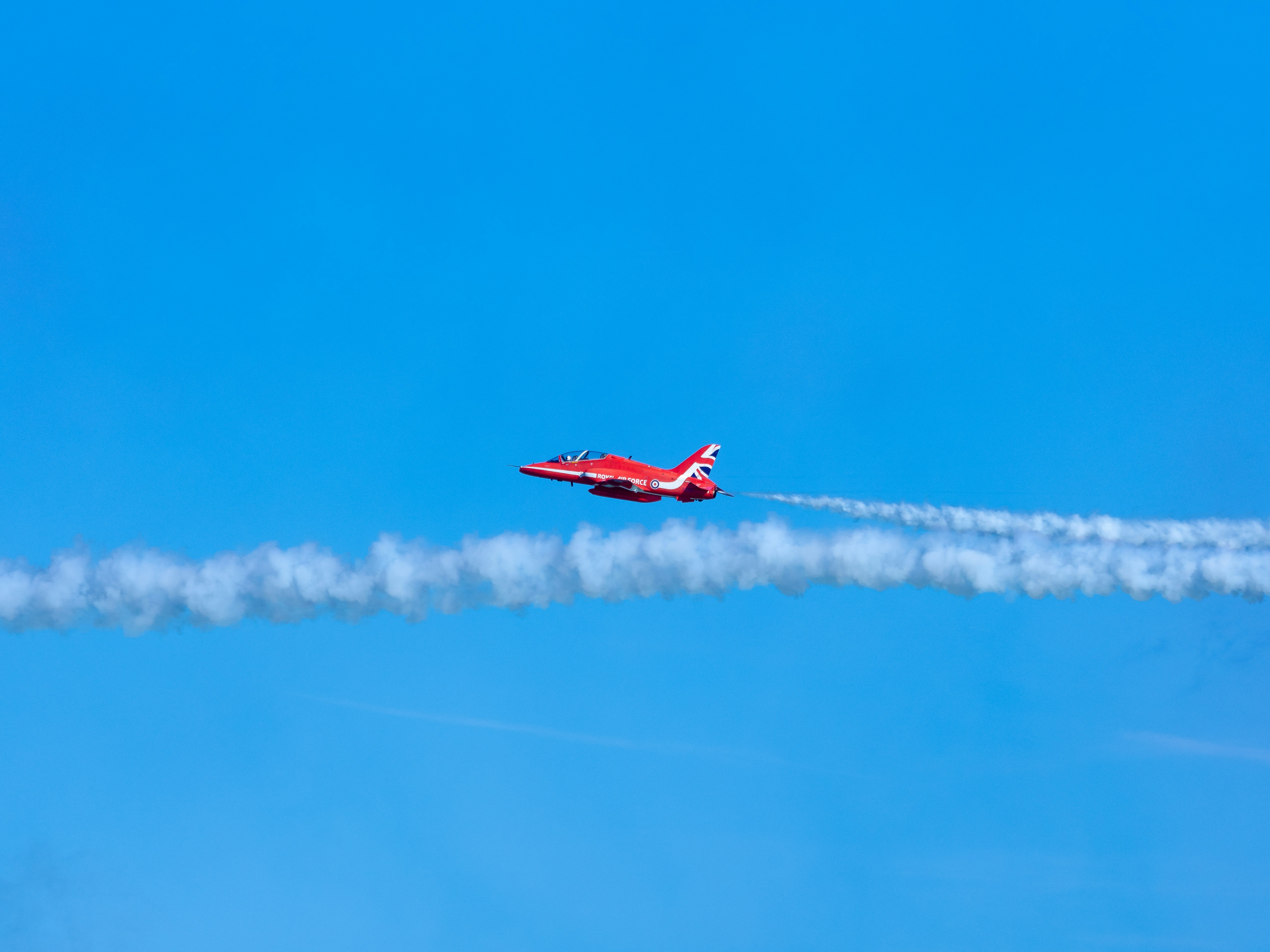 A red and white jet flying through a blue sky photo – Free Airplane ...
