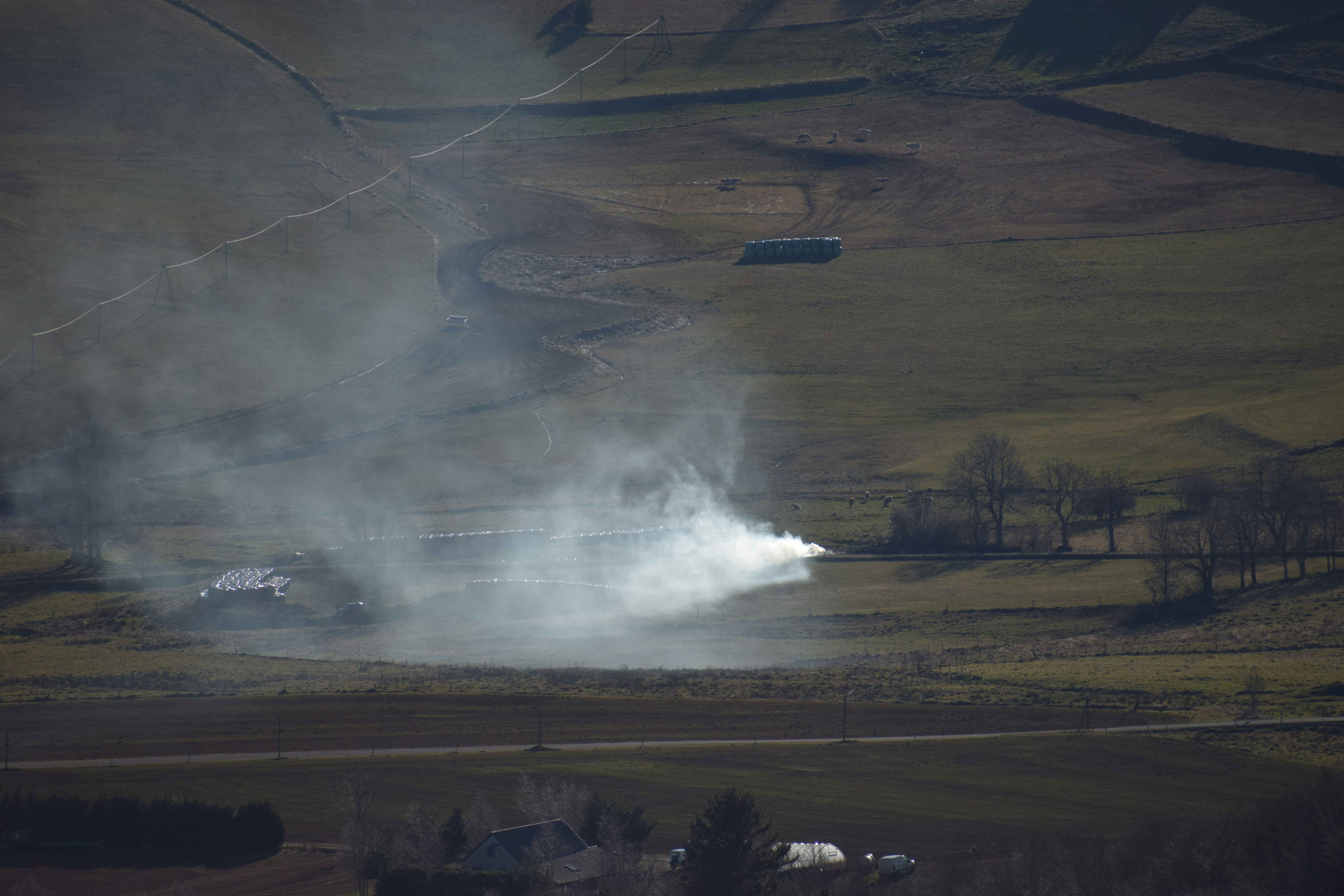 Smoke Ribbon over a Quiet Farm Valley
